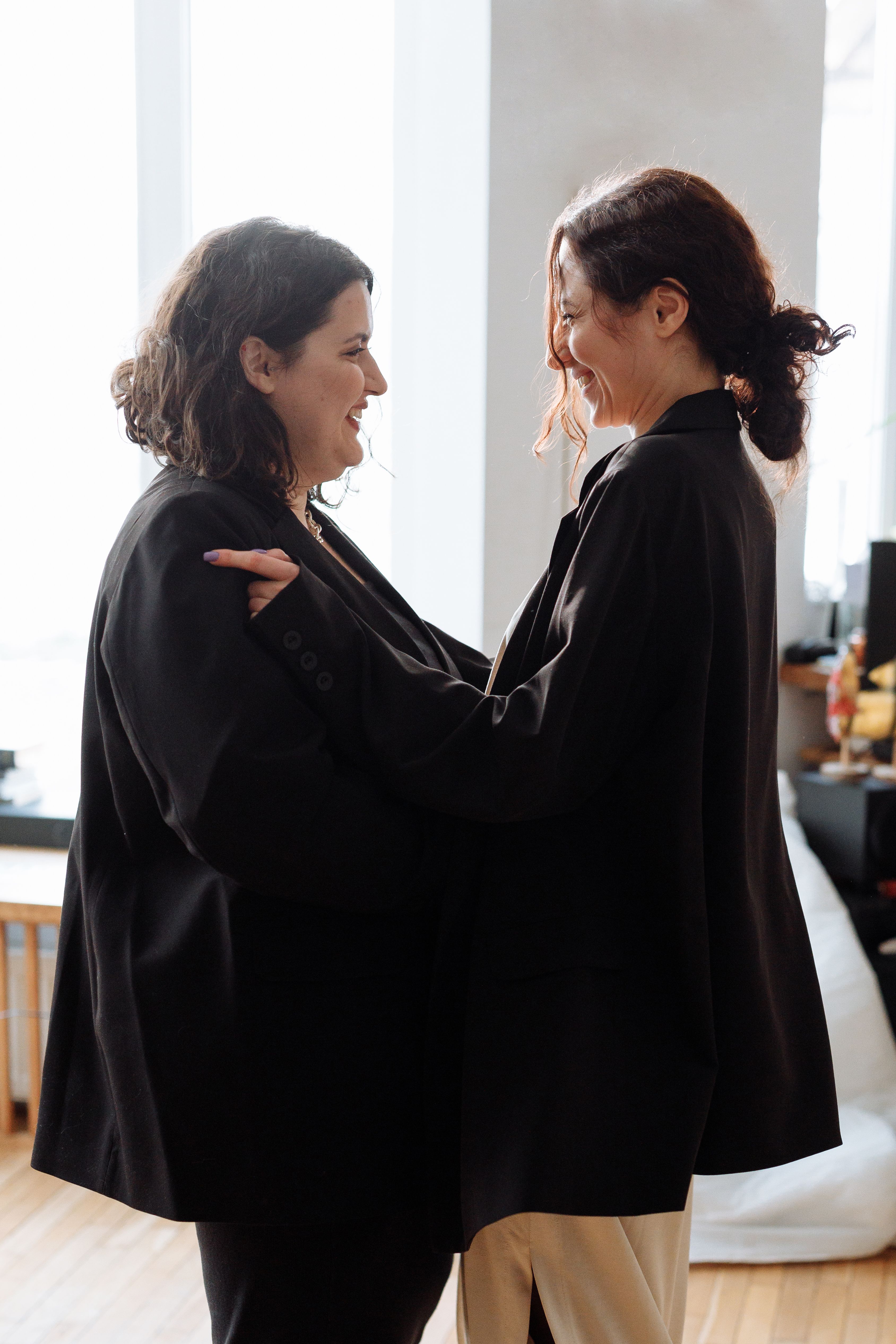 Women Standing Close Together Smiling at Each Other · Free Stock Photo