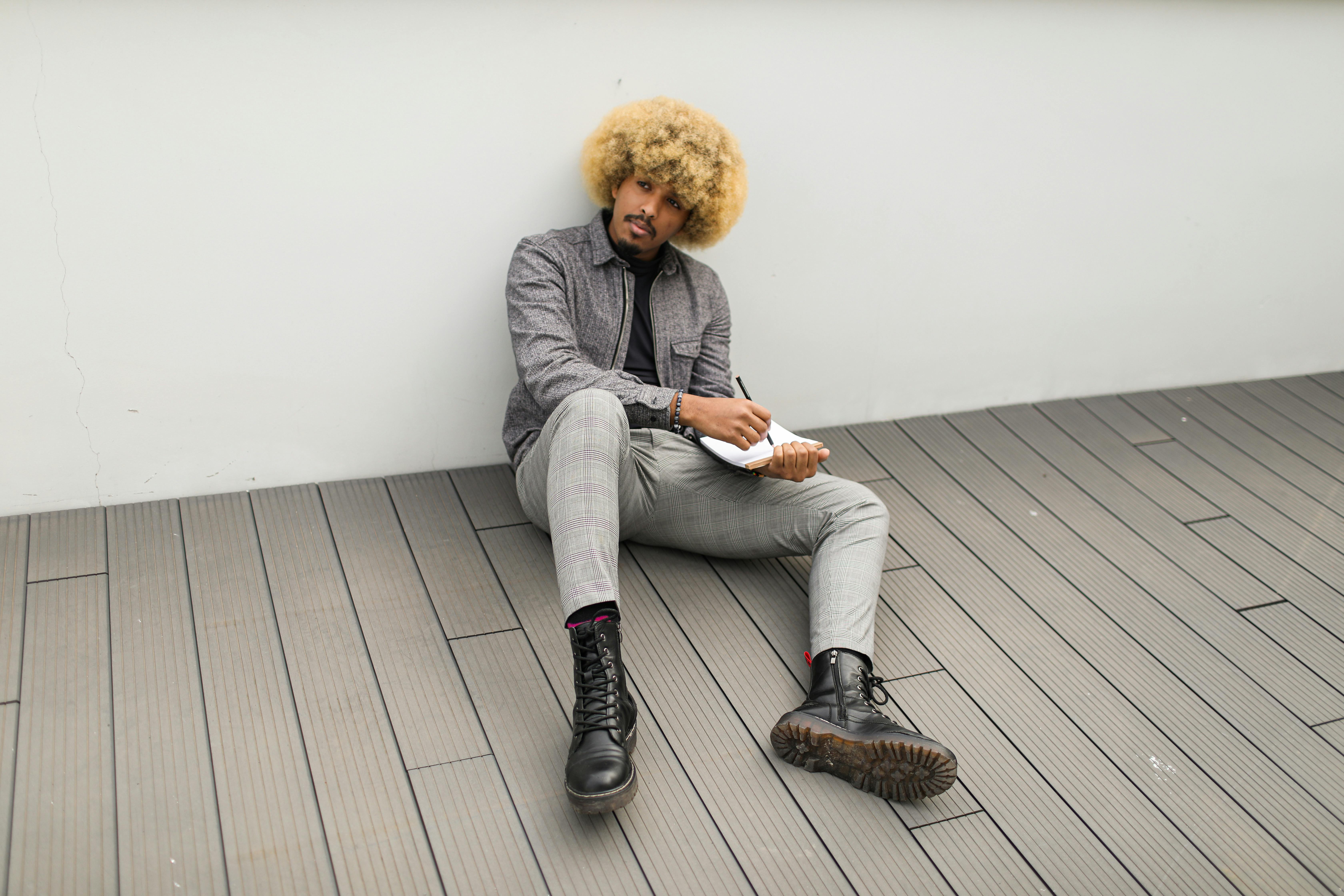 Man Looking Afar While Writing on a Notebook · Free Stock Photo