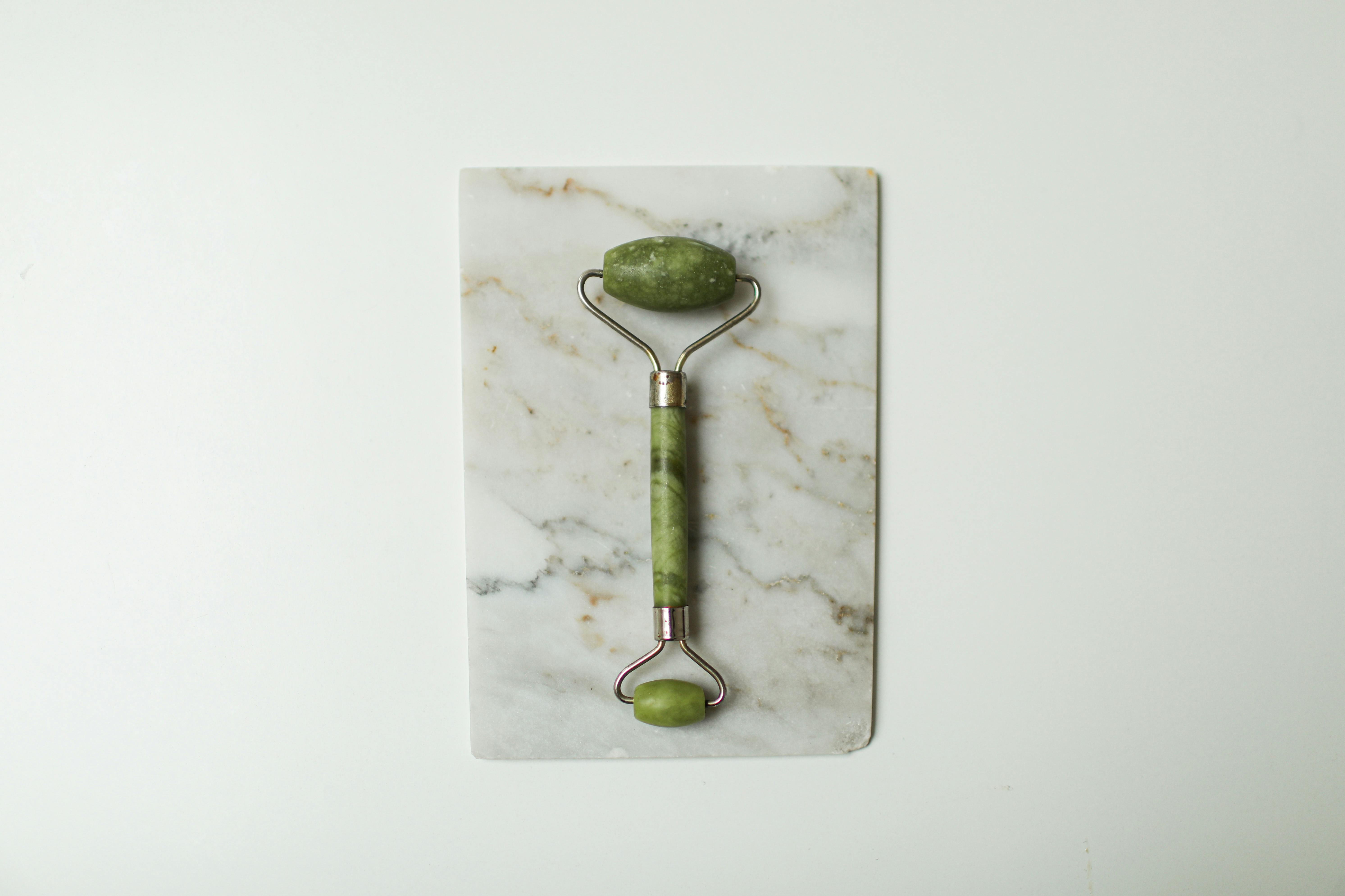 A facial Roller on a Marble · Free Stock Photo