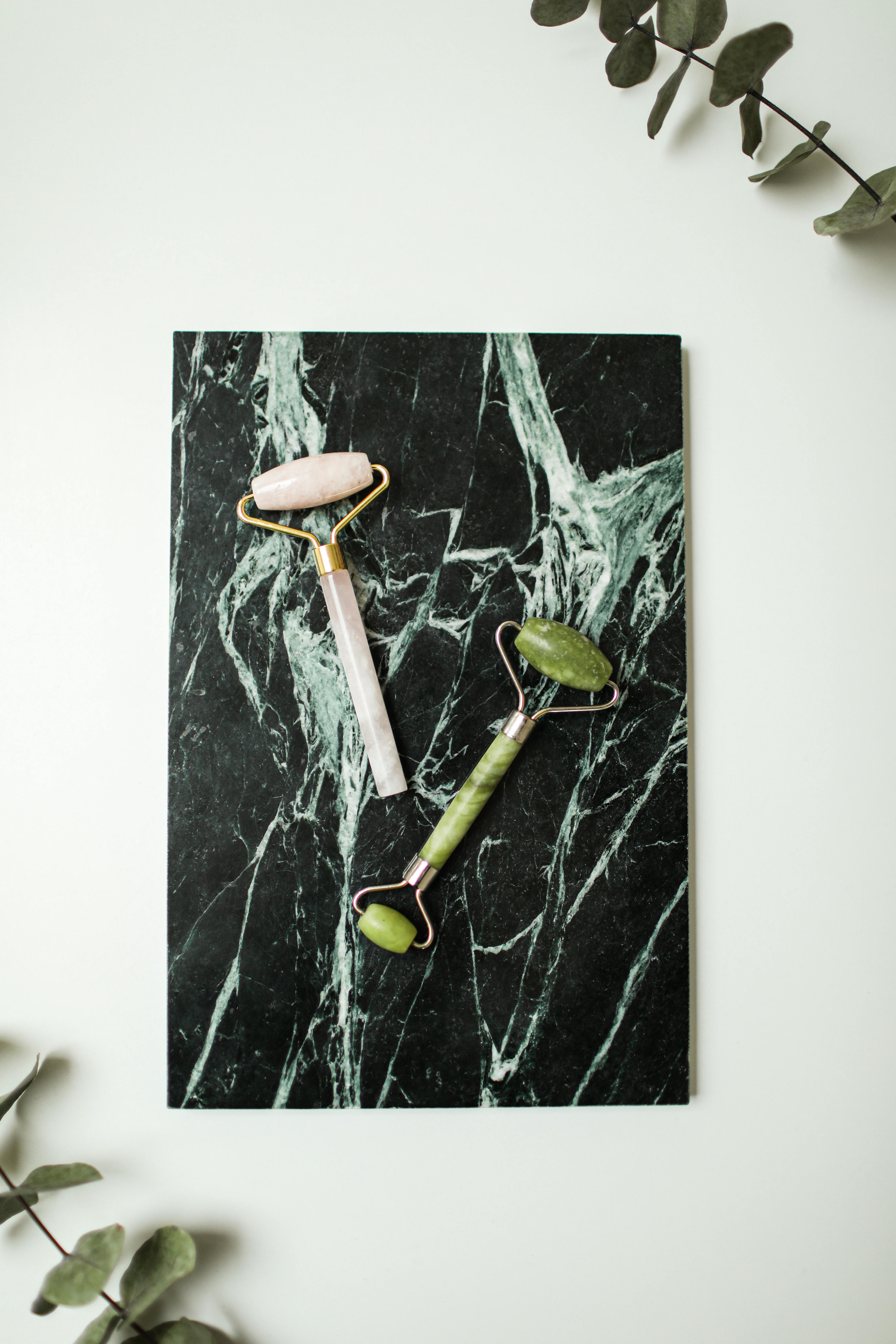 A Flatlay of Facial Rollers on a Marble · Free Stock Photo