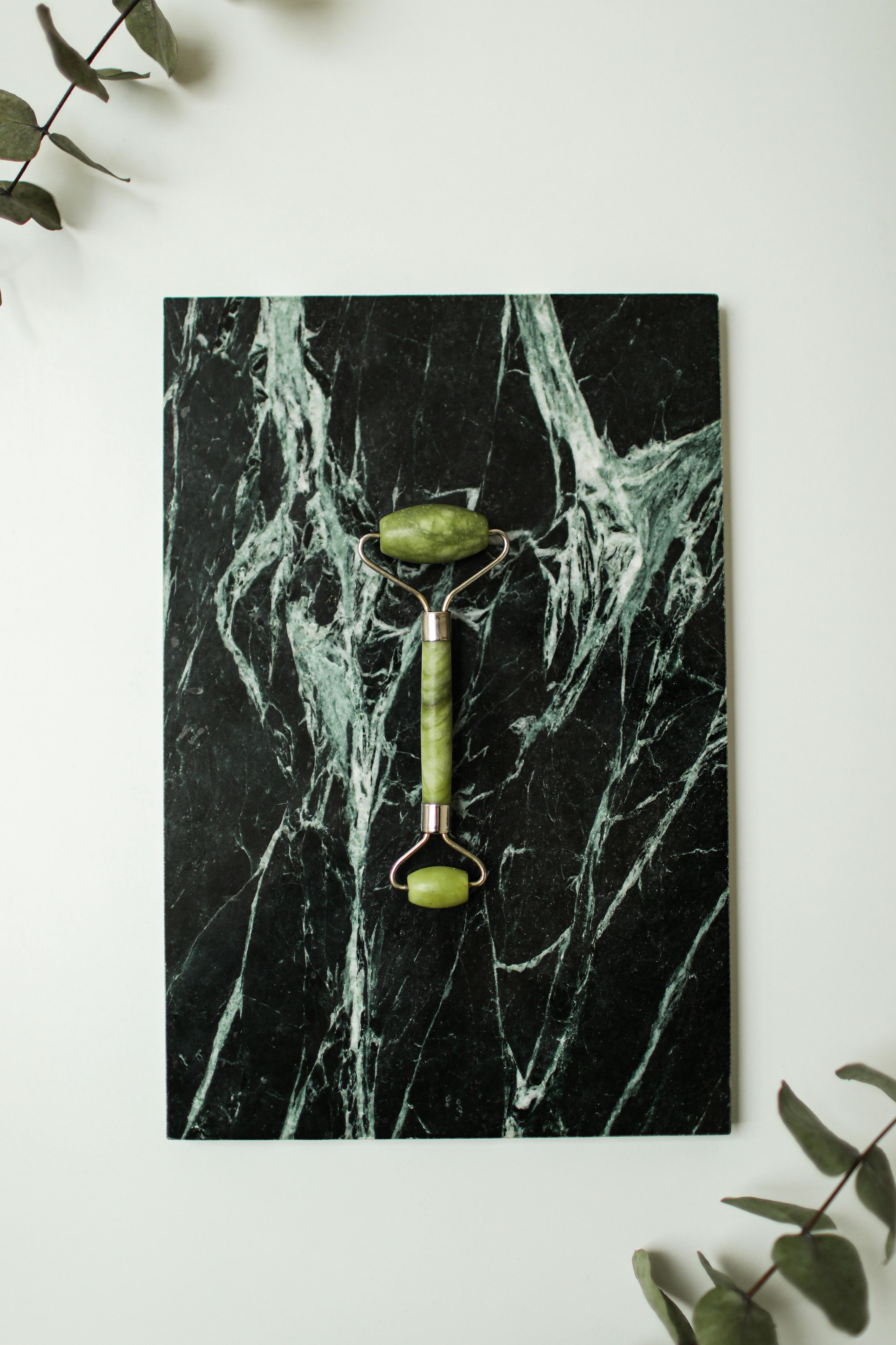 A Flatlay of Face Roller on a Marble · Free Stock Photo