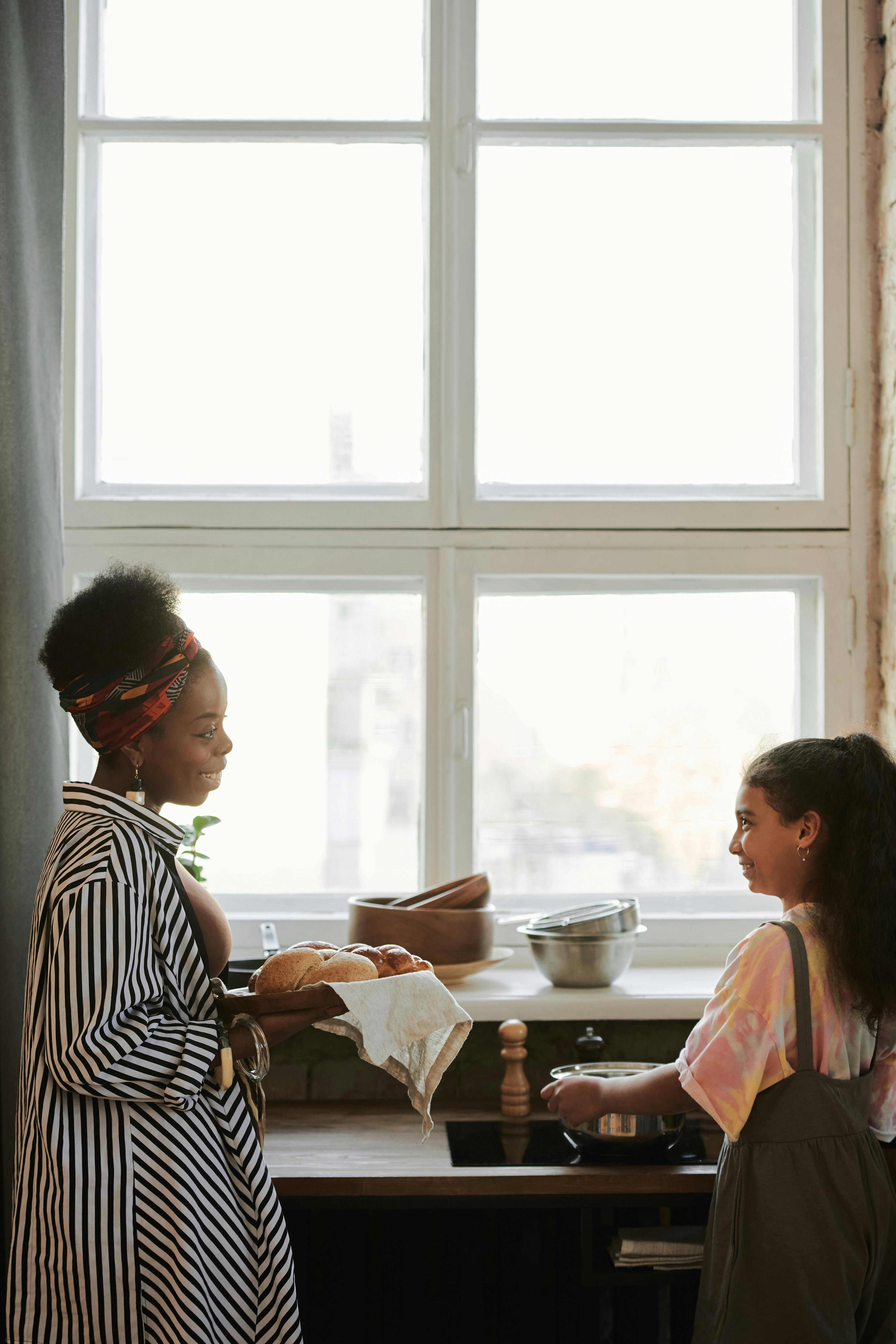 Woman and Cute Girl Standing in the Kitchen · Free Stock Photo