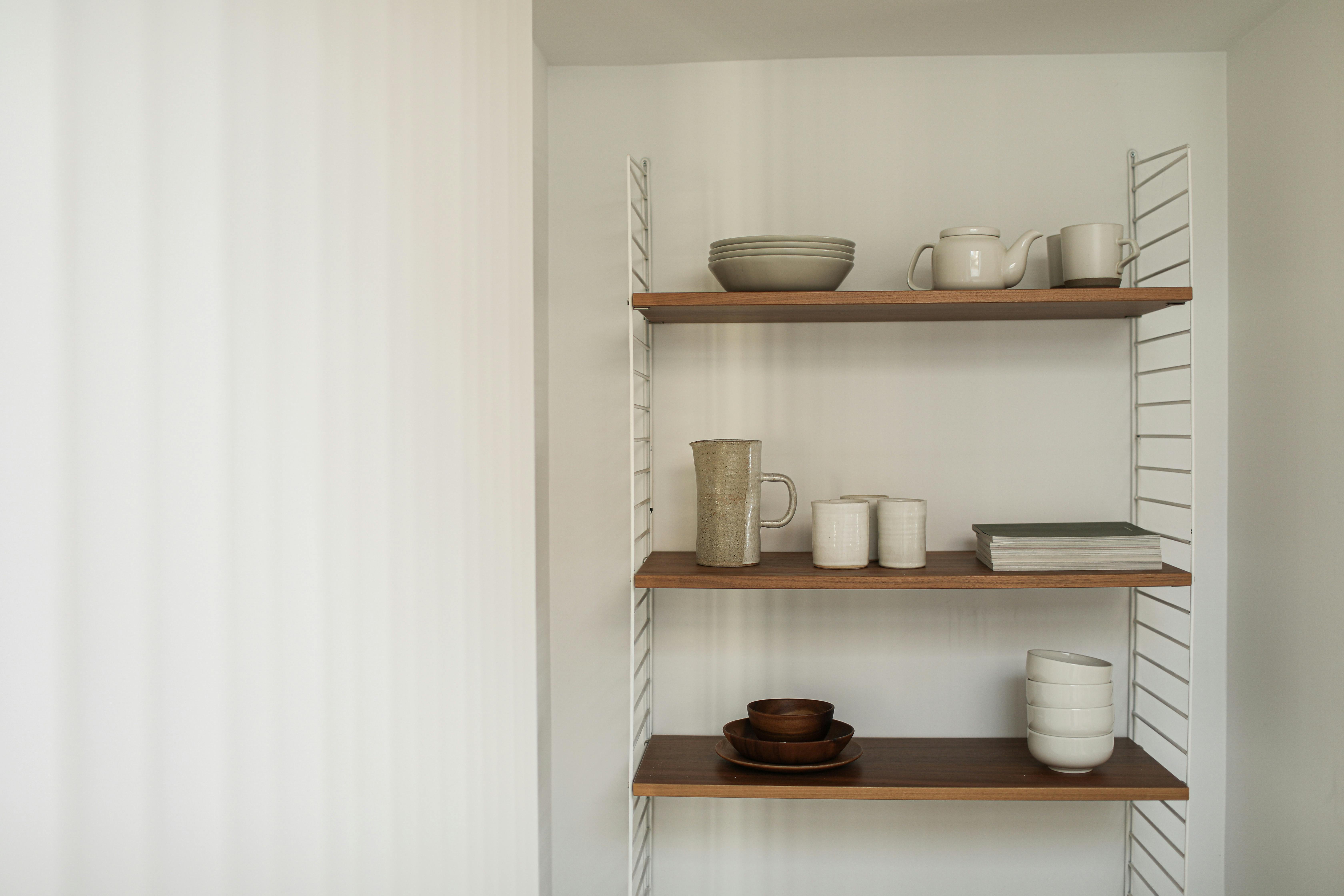 Ceramic Tableware on a Shelf in a Minimalist Interior · Free Stock Photo