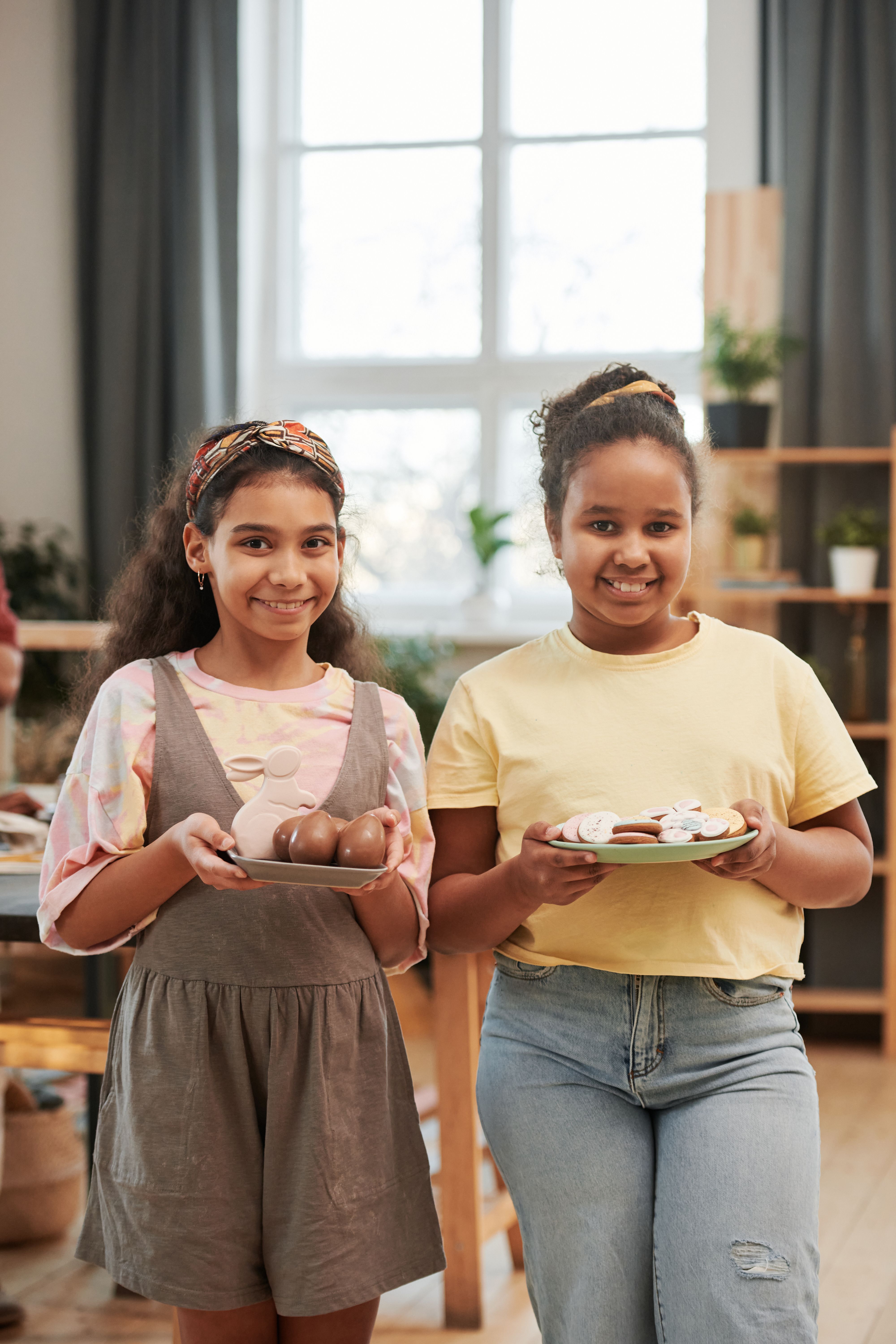 Girls Carrying Plates with Goodies · Free Stock Photo