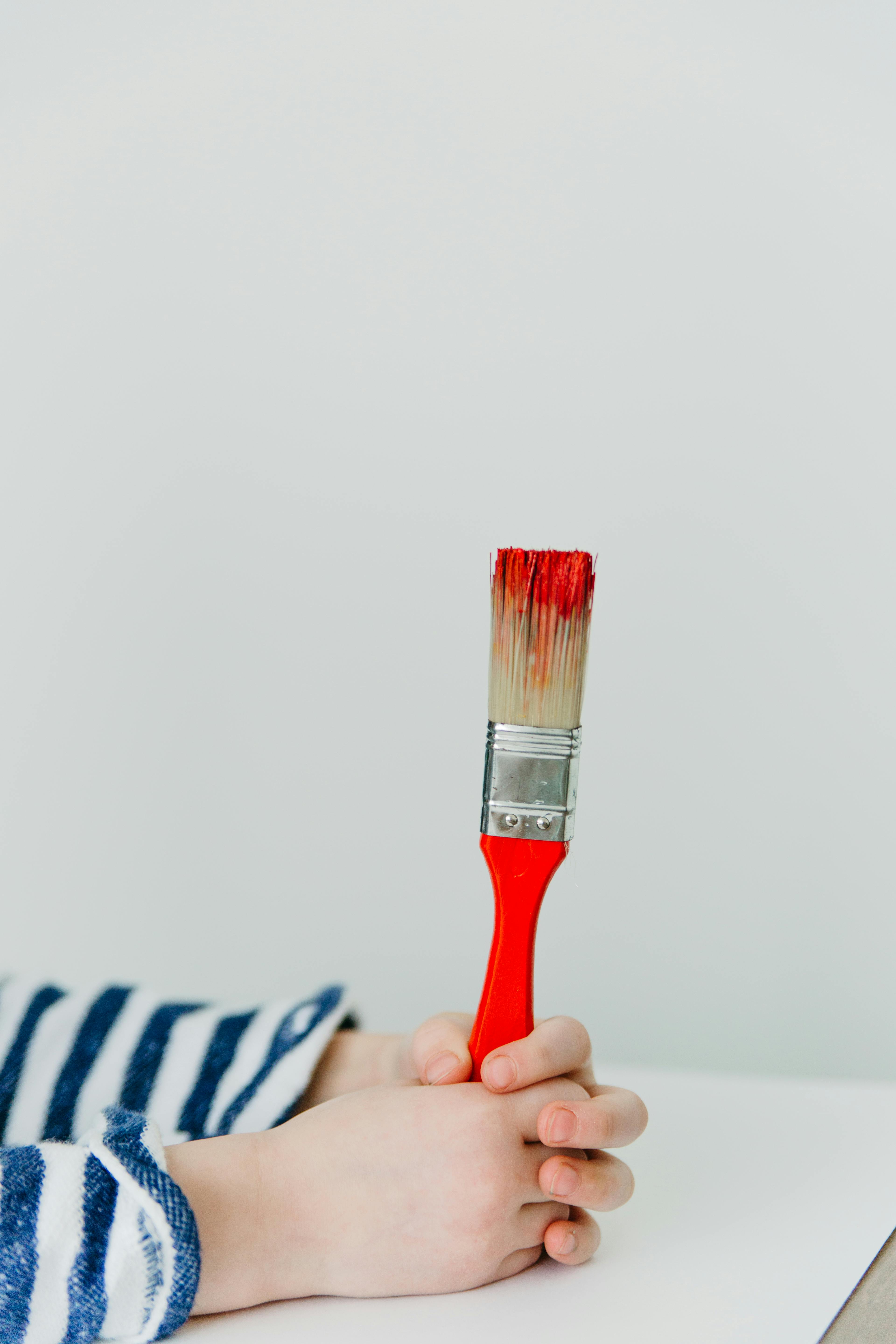 A Child Painting using a Paintbrush · Free Stock Photo