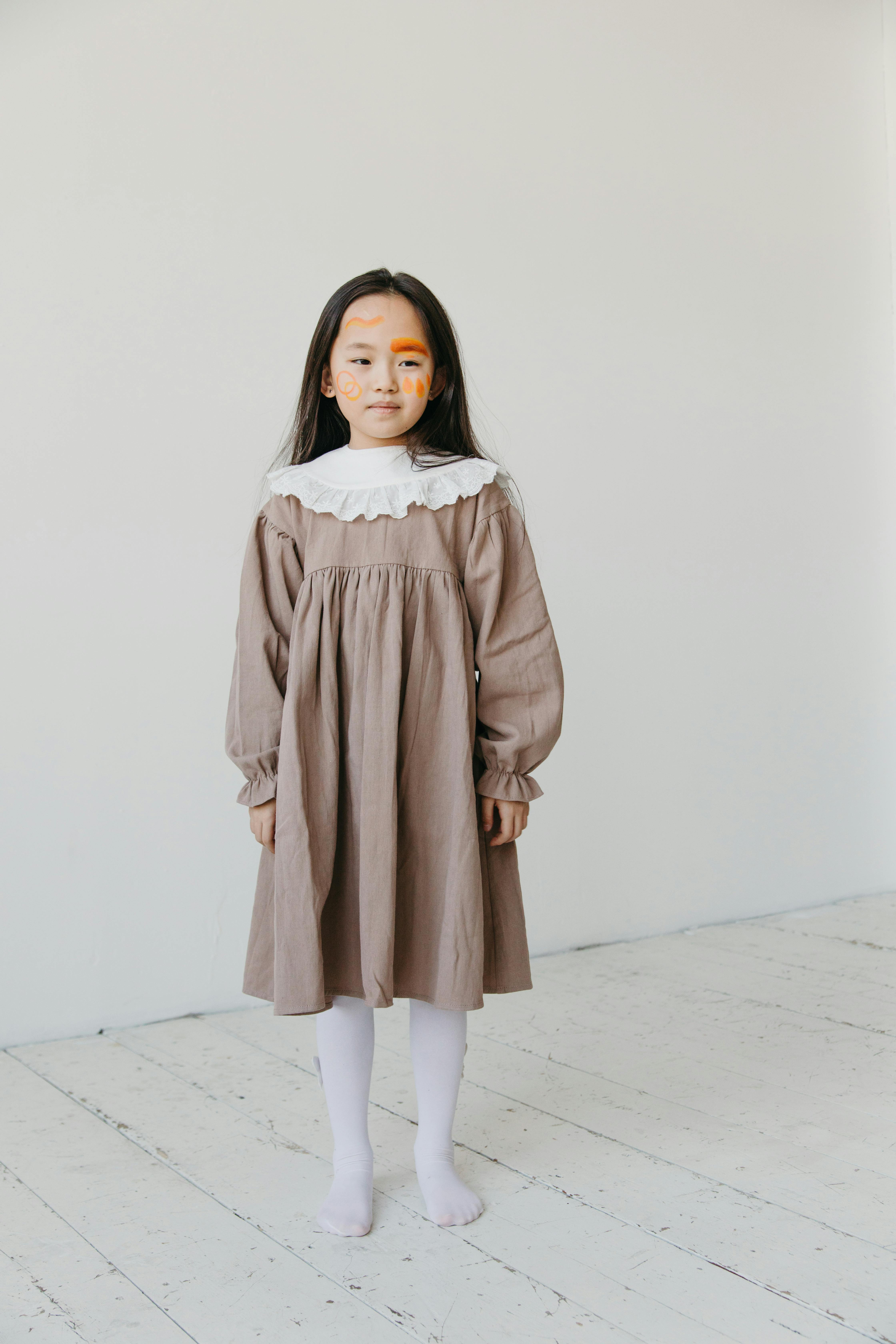 Young Girl Wearing a Brown Dress · Free Stock Photo