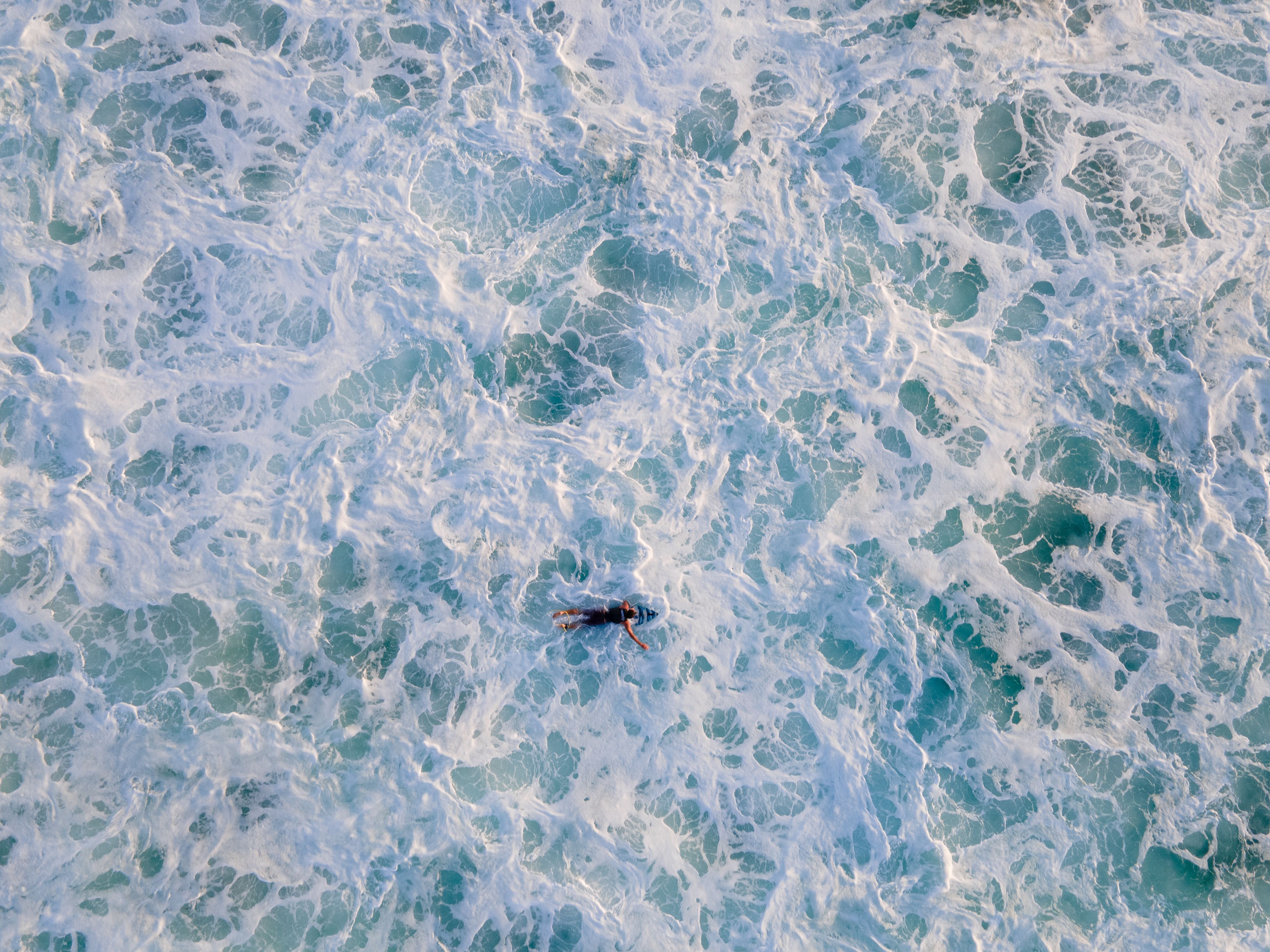 An Aerial Photography of a Person Surfing on the Sea · Free Stock Photo