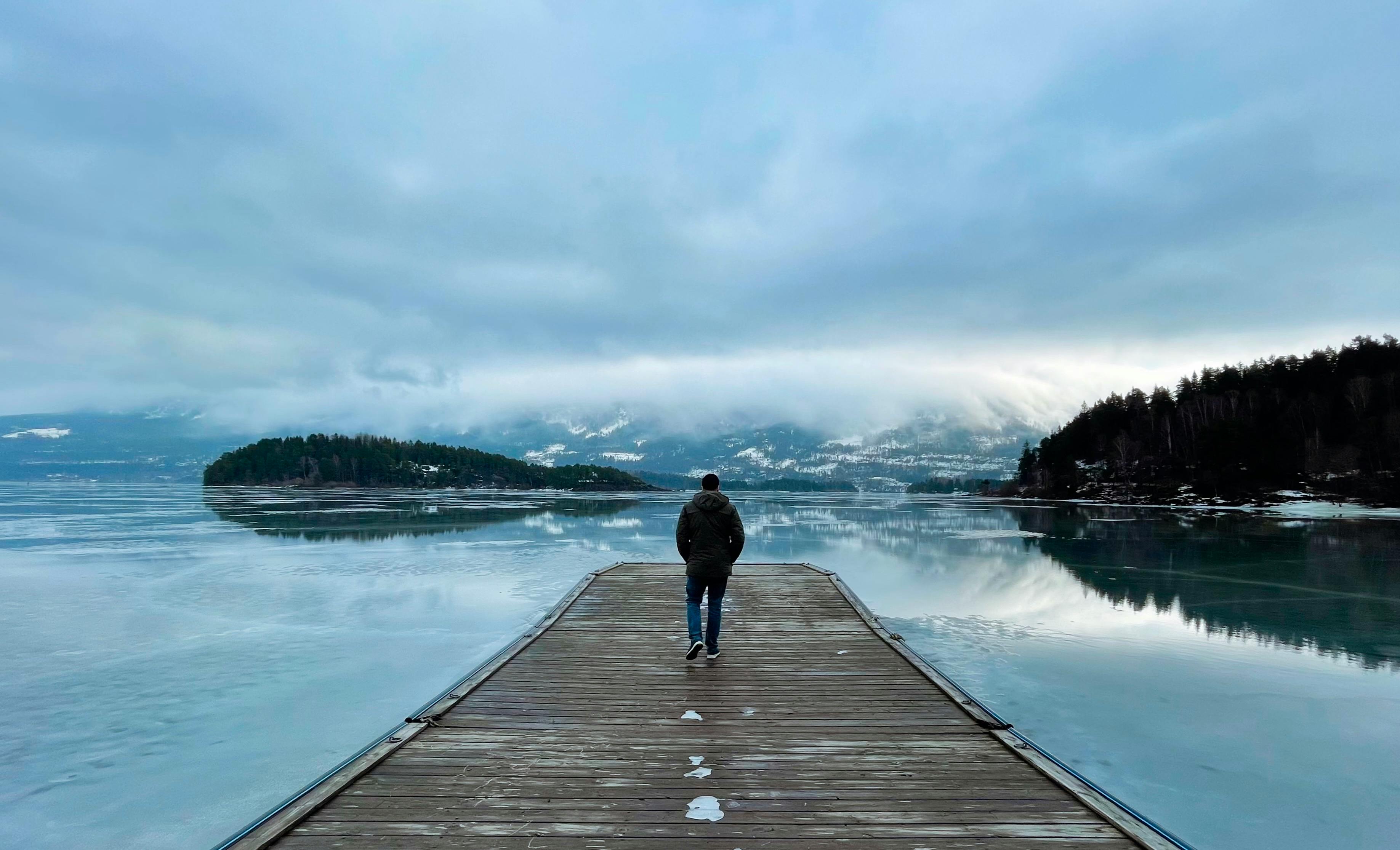 Person Walking on Wooden Dock · Free Stock Photo