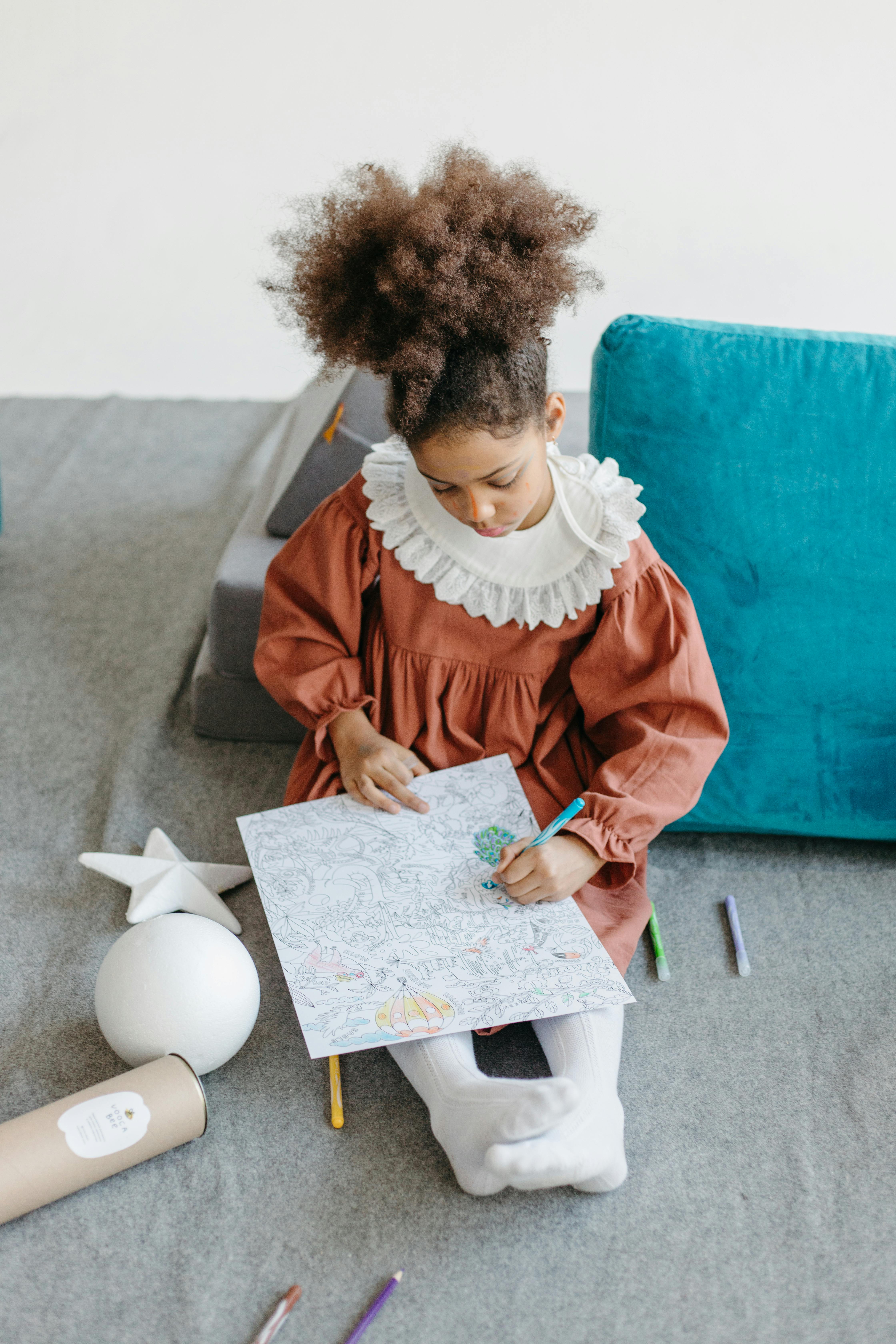 A Young Girl Doing a Drawing · Free Stock Photo