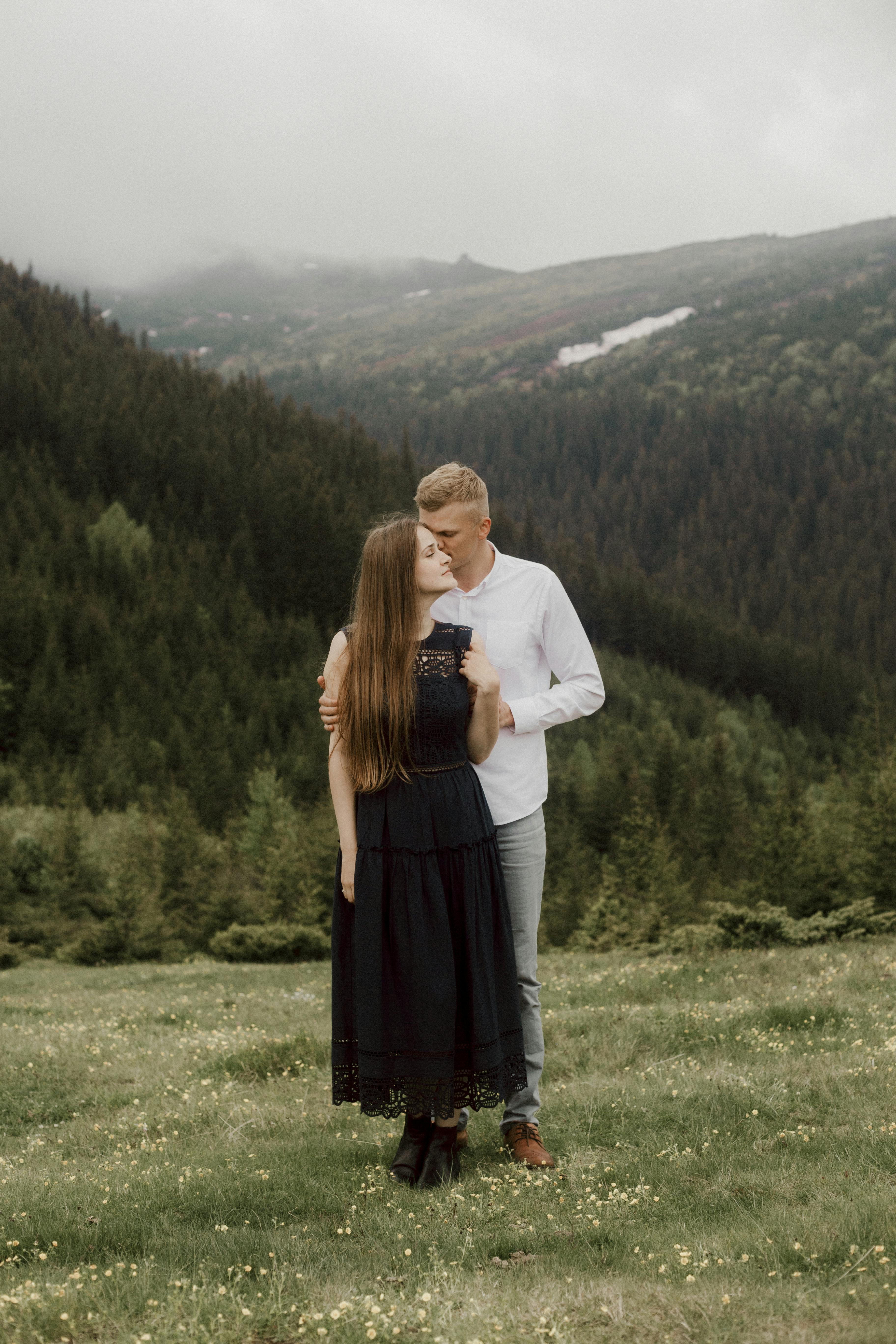 Man Standing Behind a Woman in Black Dress · Free Stock Photo