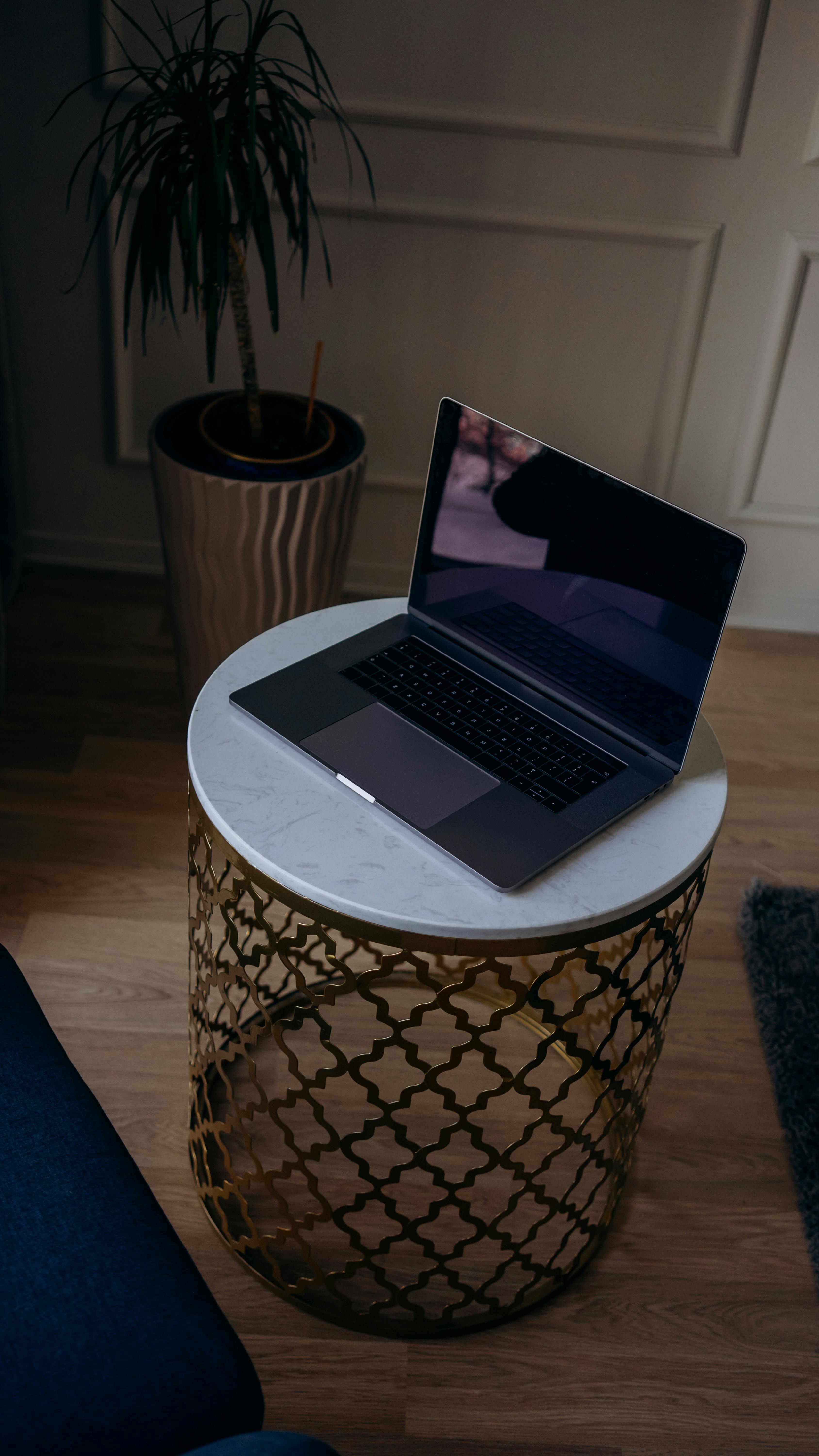 Black Laptop on a Round Table · Free Stock Photo