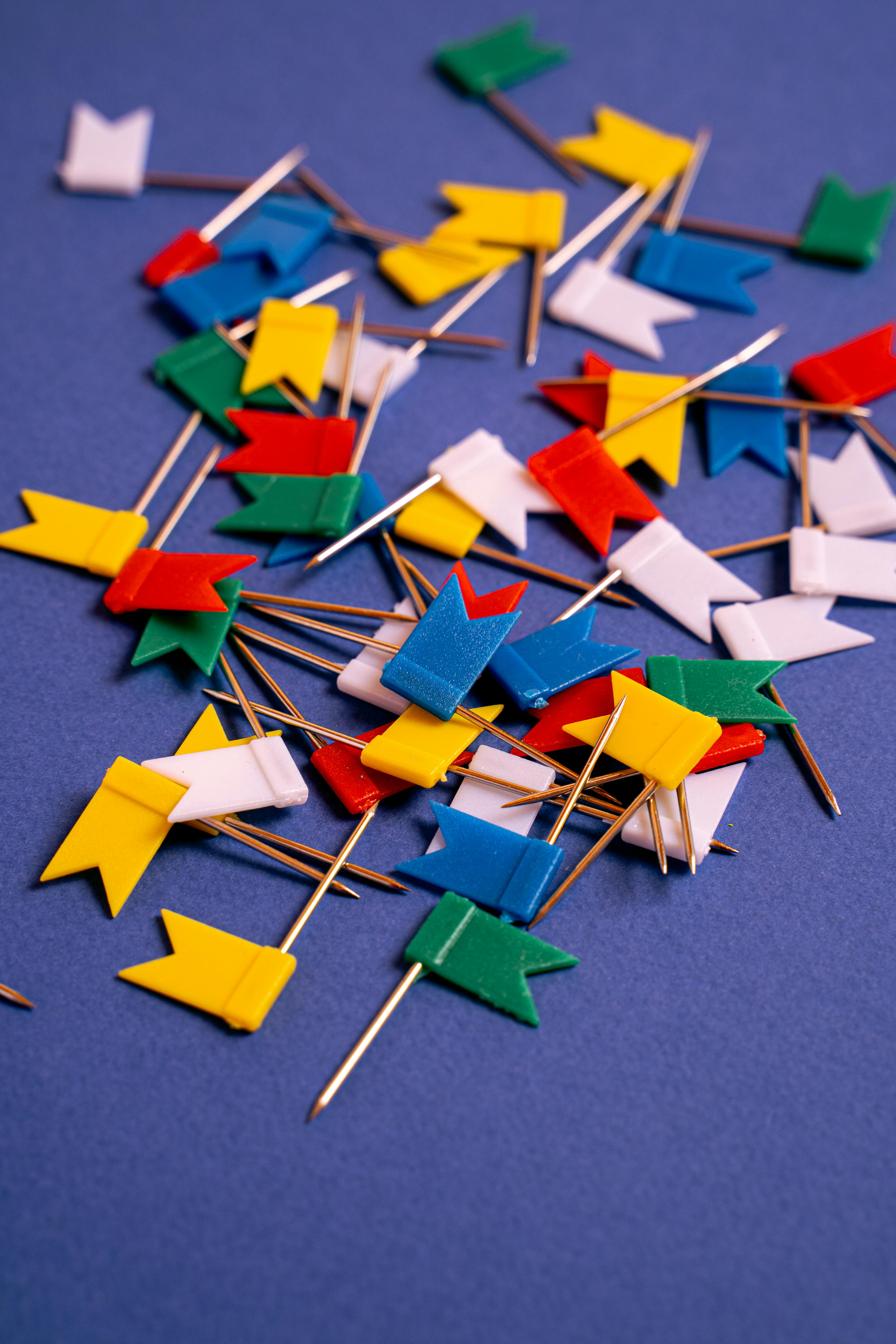 Close up of Small Multicoloured Plastic Flags on Purple Background ...