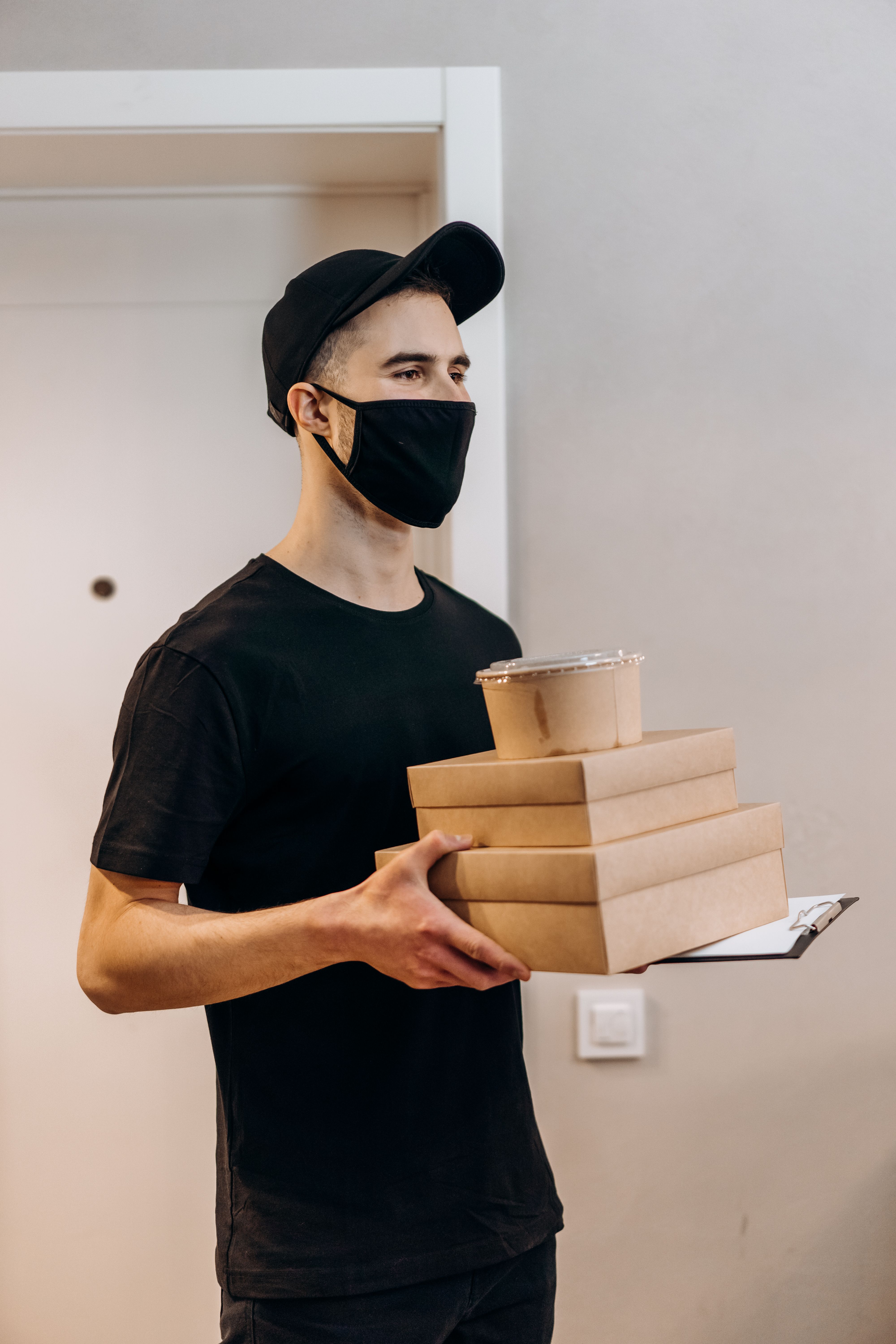 A Man in Black Crew Neck T-shirt Making Food Delivery · Free Stock Photo