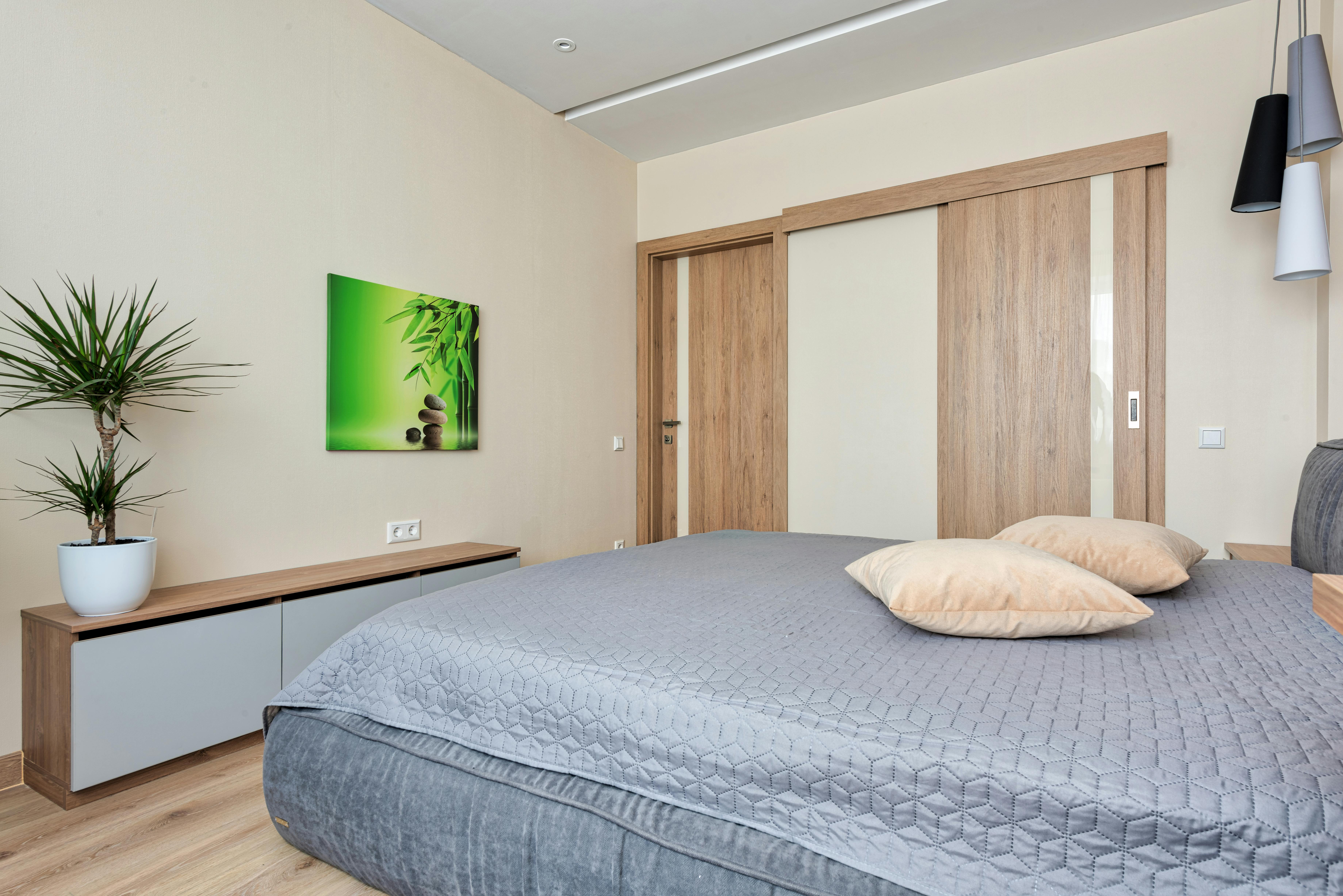 Gray Bed beside Brown Wooden Door · Free Stock Photo