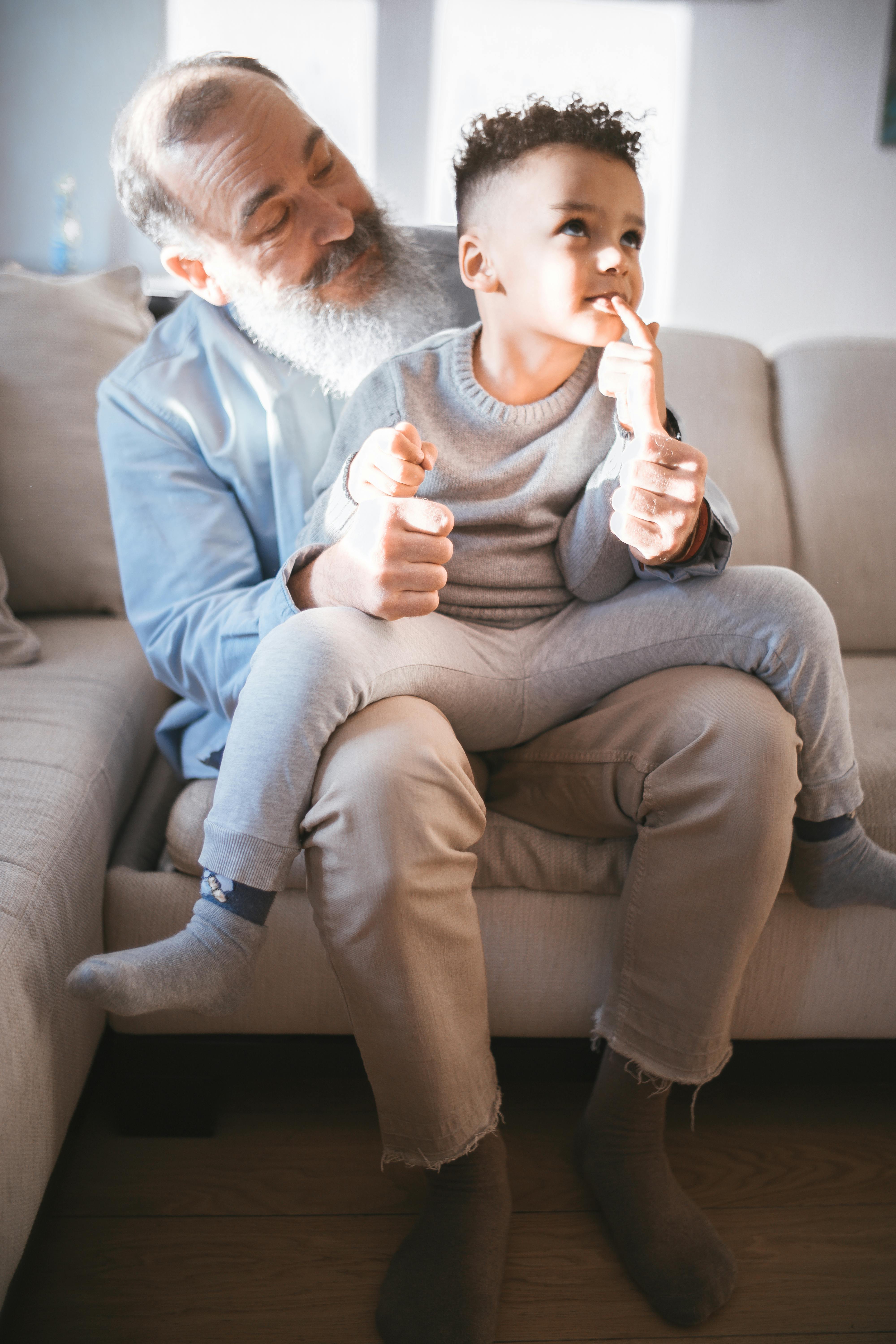 A Boy Sitting on the Adult Man's Lap · Free Stock Photo