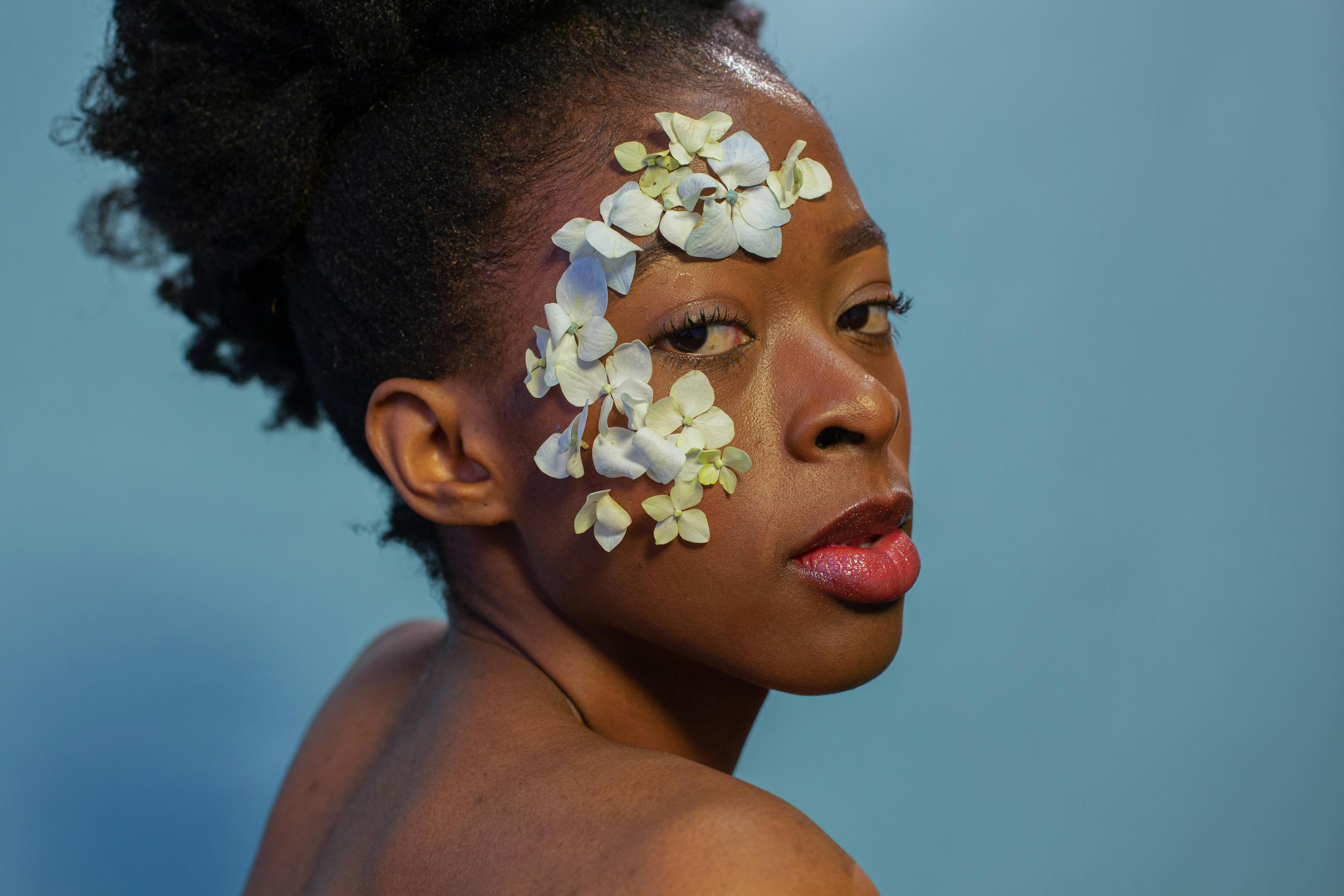 Sad ethnic female in traditional clothes on grassy lawn · Free Stock Photo
