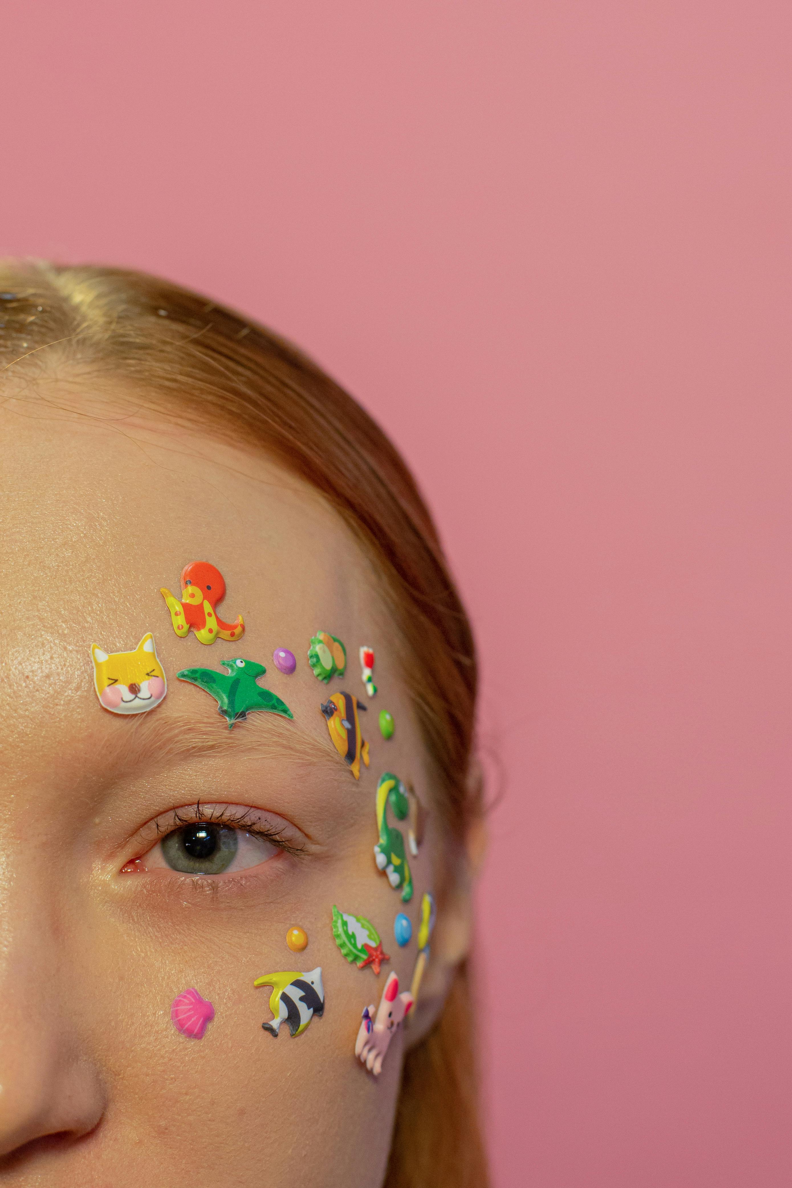 Bald woman with stickers on face showing shush sign · Free Stock Photo