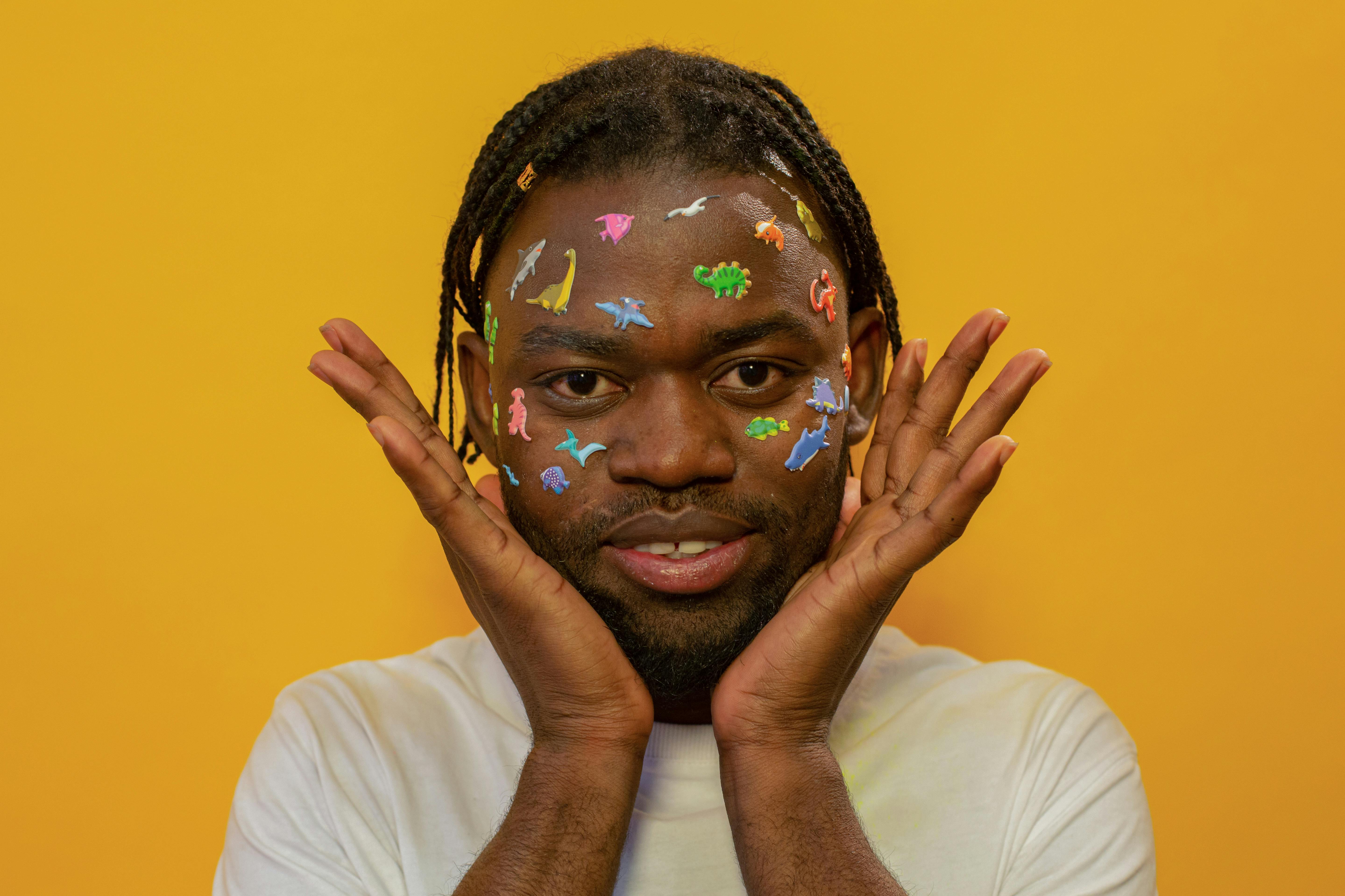Crop black man with animal stickers on face · Free Stock Photo
