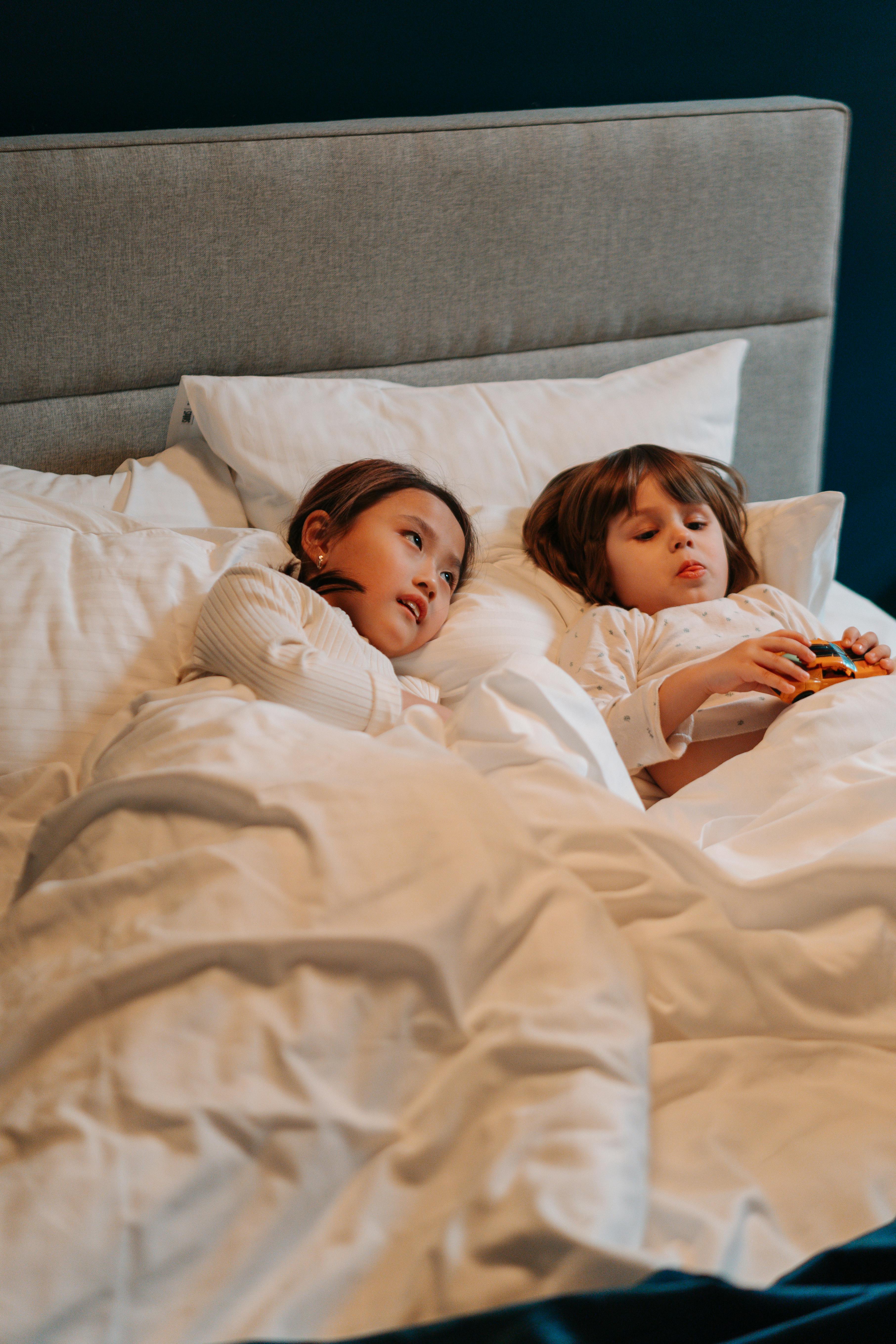 Children in Bed with White Linens · Free Stock Photo
