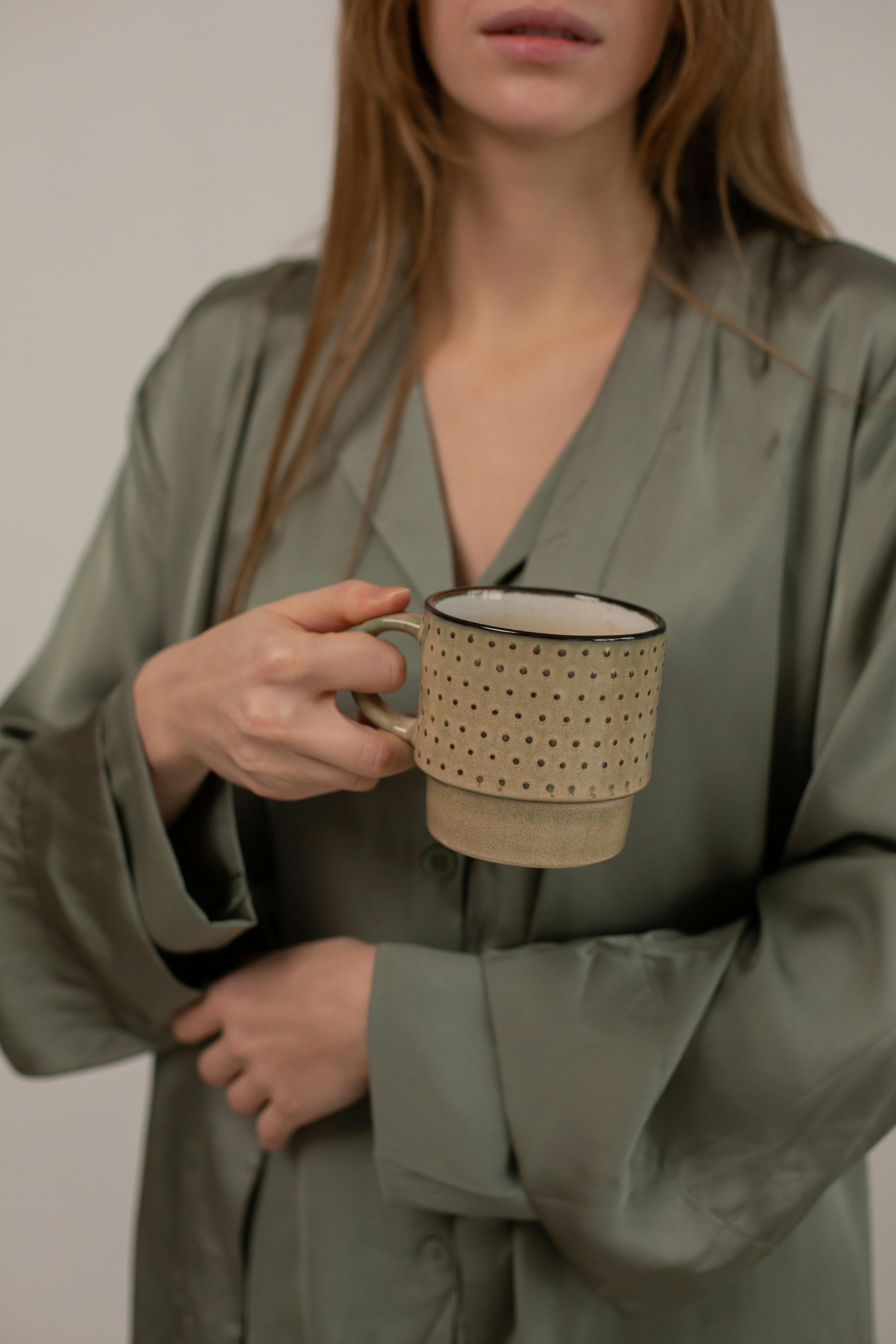 Woman in Sleepwear Holding a Cup · Free Stock Photo