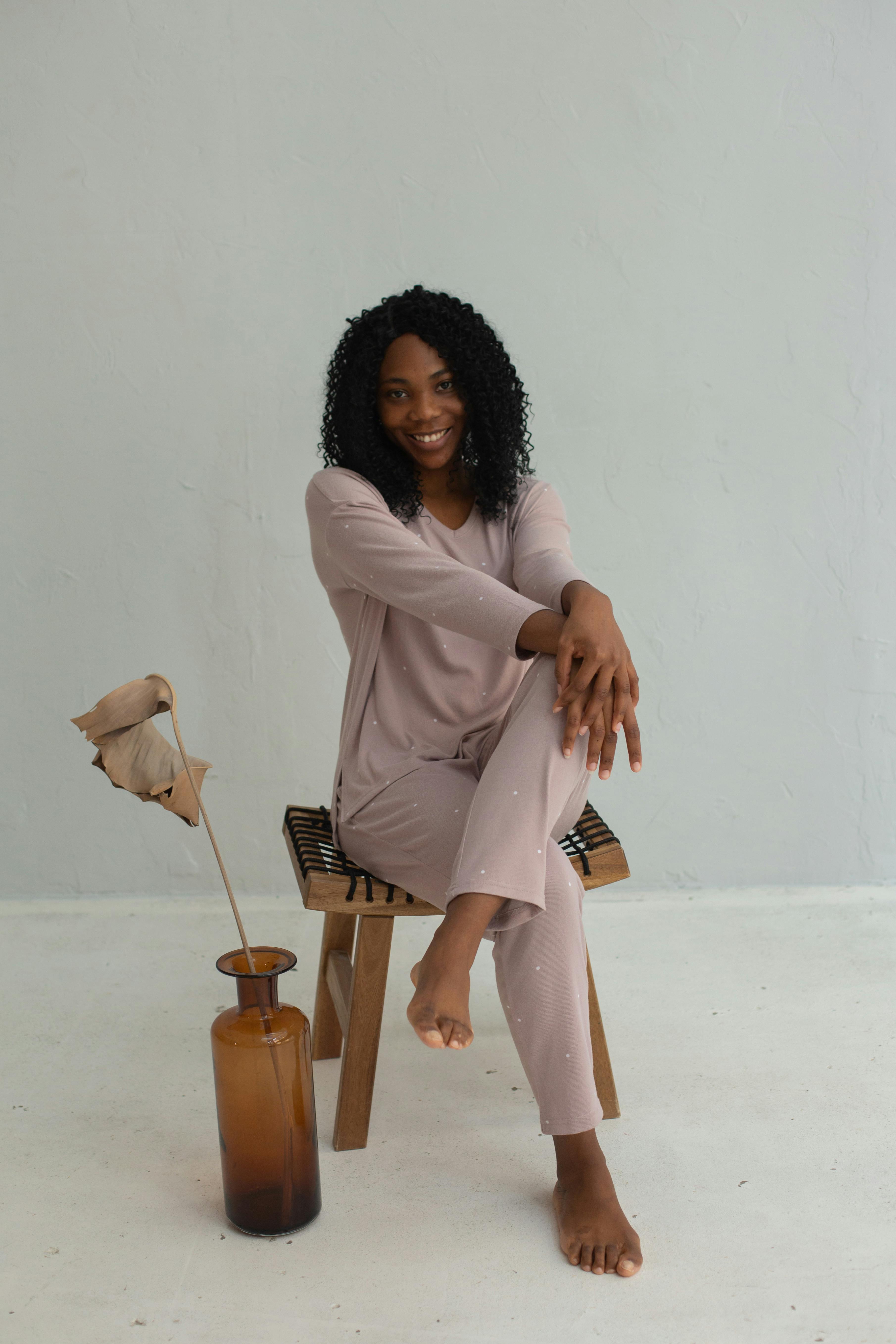 A Woman Sitting on Wooden Chair · Free Stock Photo