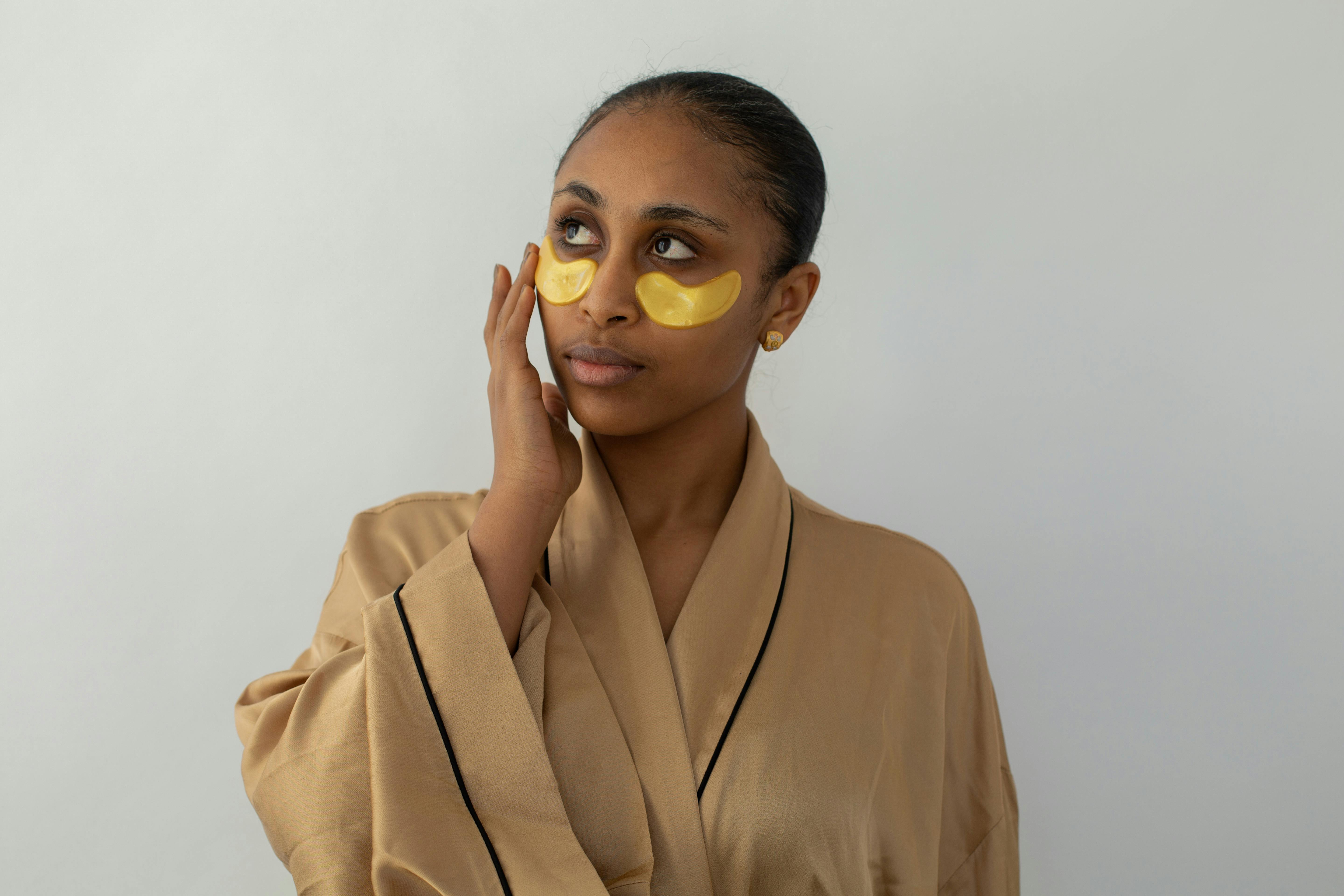 Woman Putting on Eye Mask · Free Stock Photo