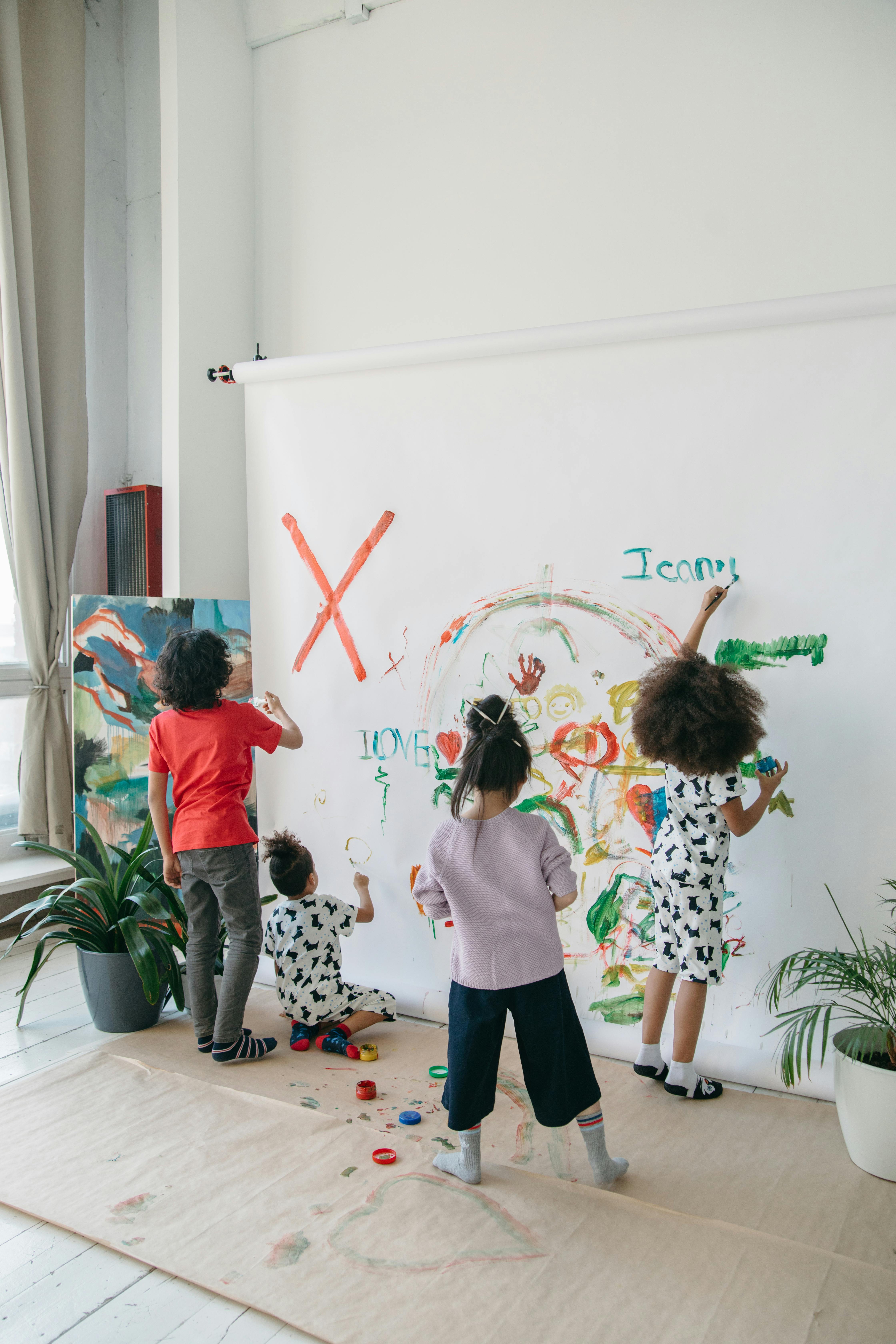 Back View Shot of Kids Designing Wall · Free Stock Photo