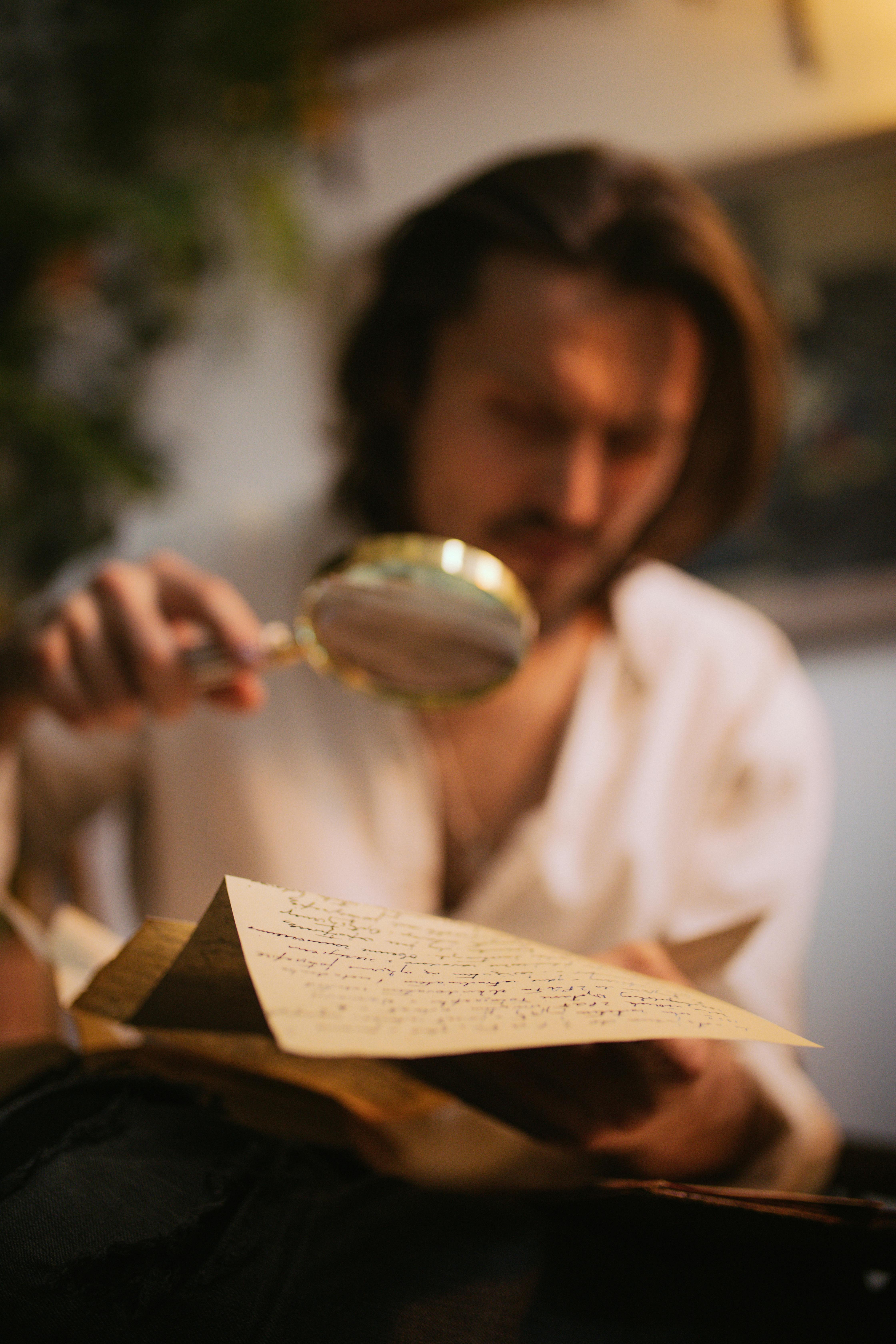 A Person Reading with a Magnifying Glass · Free Stock Photo