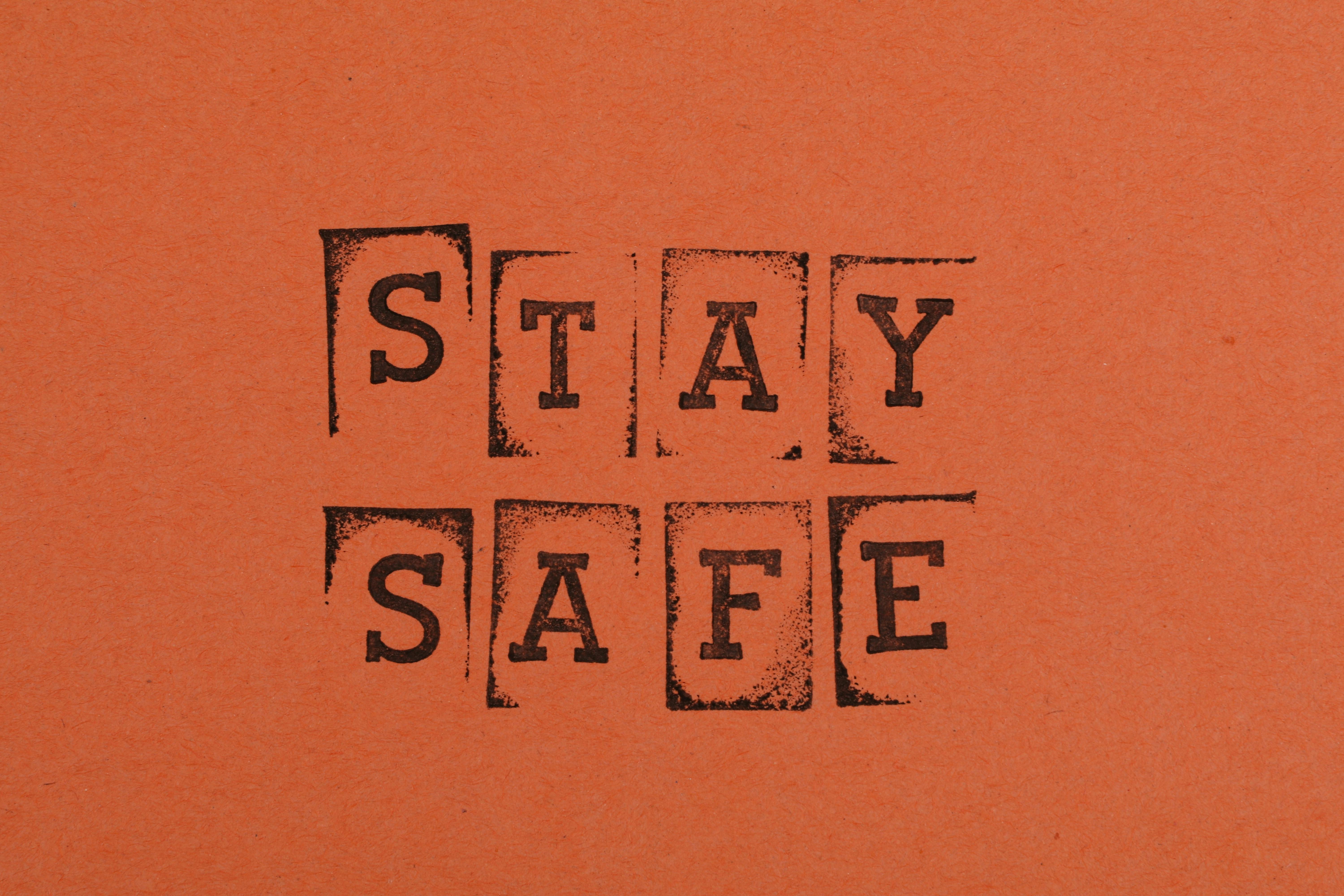 A Stay Safe Text on an Orange Background · Free Stock Photo