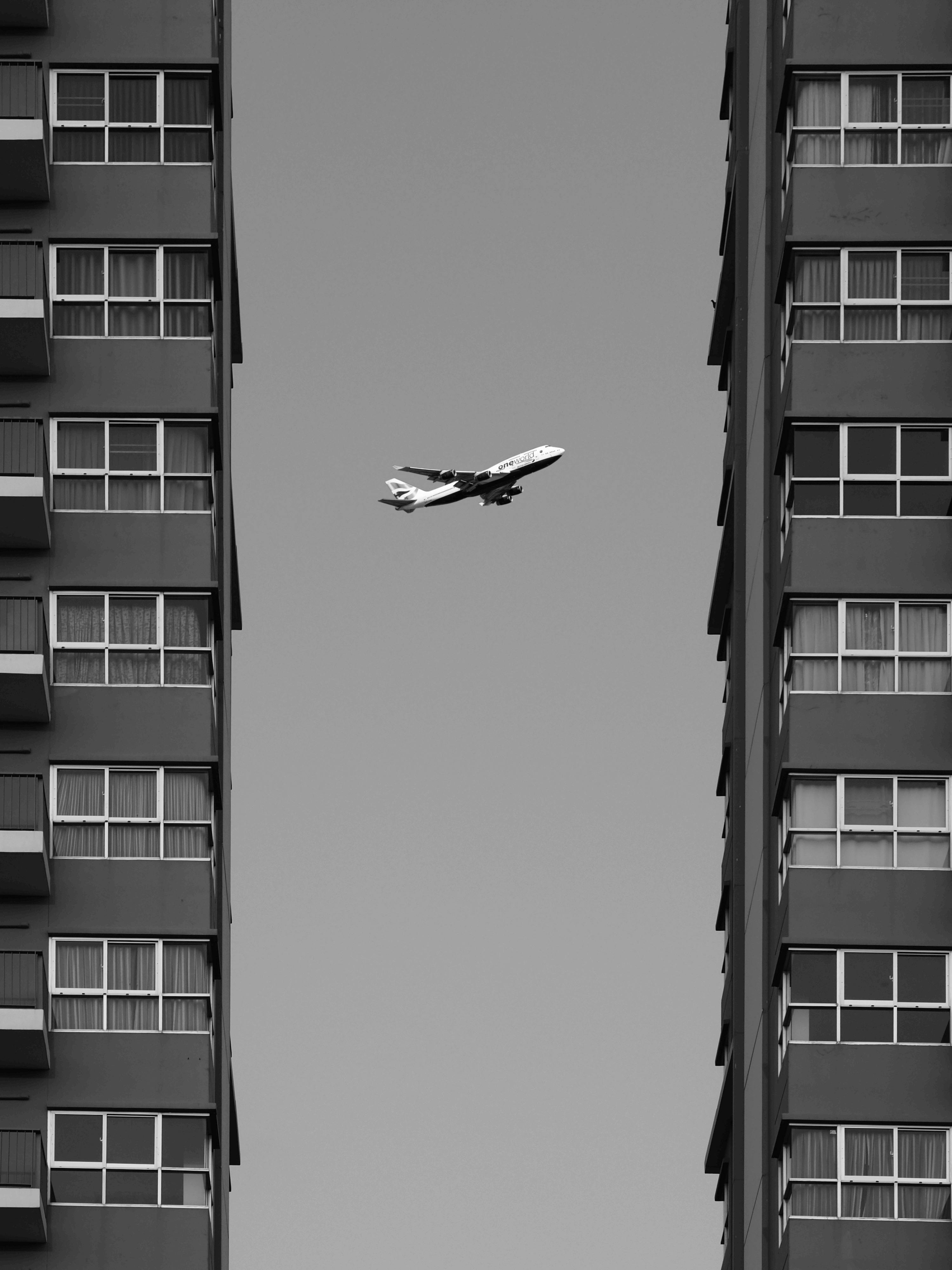 An Airplane Between Two Buildings · Free Stock Photo