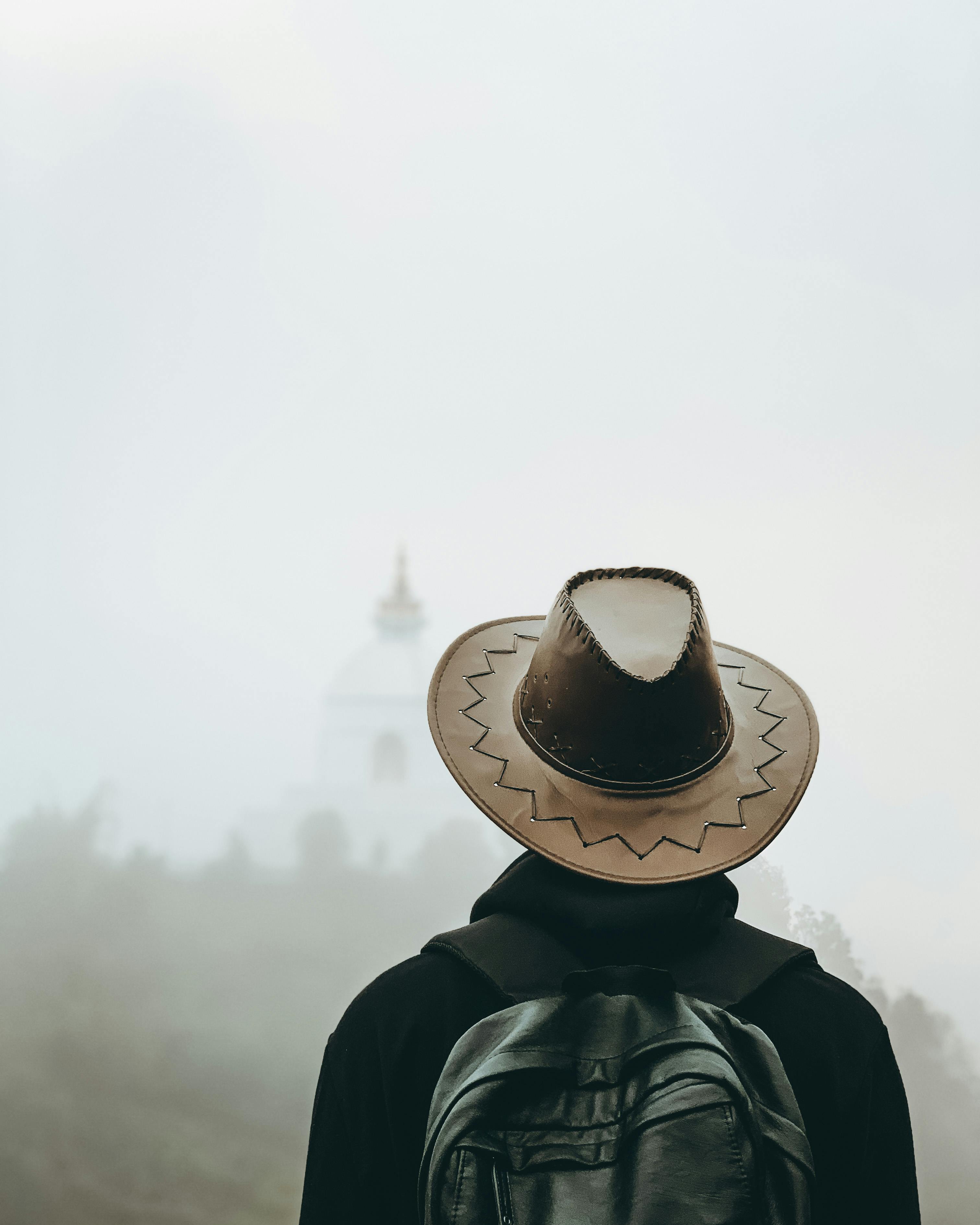 Back View Of Man Wearing Cowboy Hat and Black Coat · Free Stock Photo