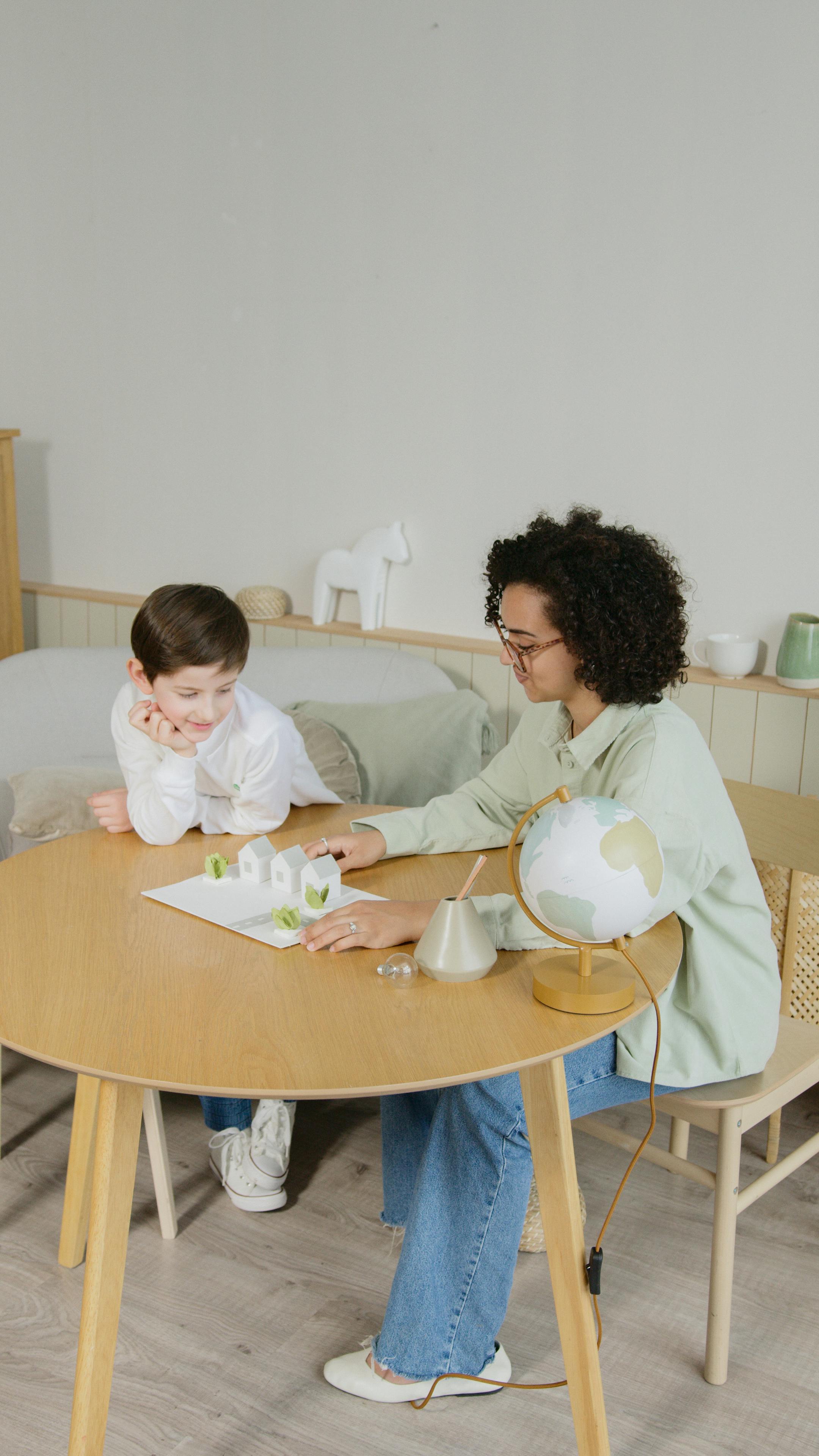 Teacher and Student Making a Project · Free Stock Photo