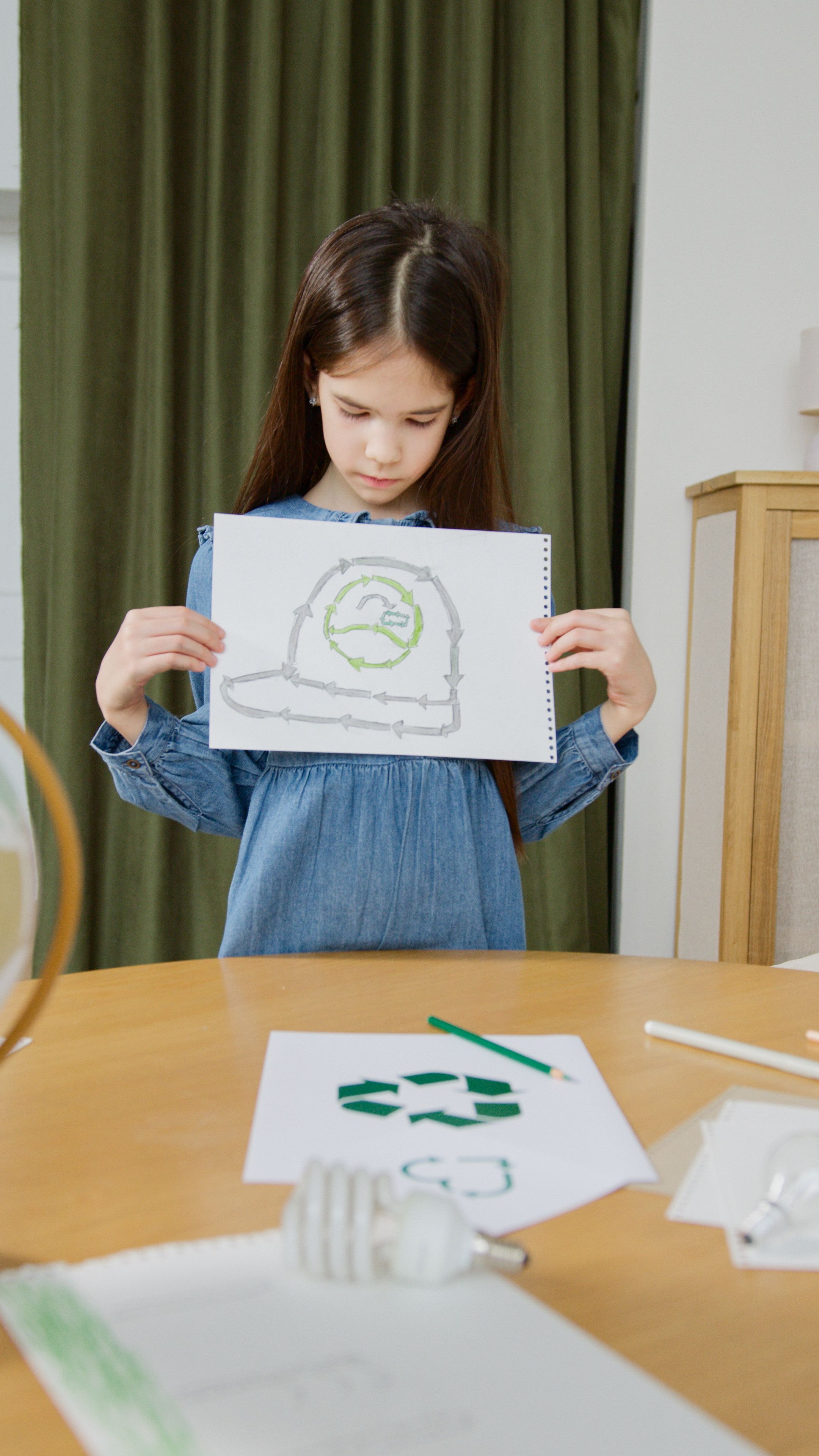 Young Girl Holding Her Drawing · Free Stock Photo