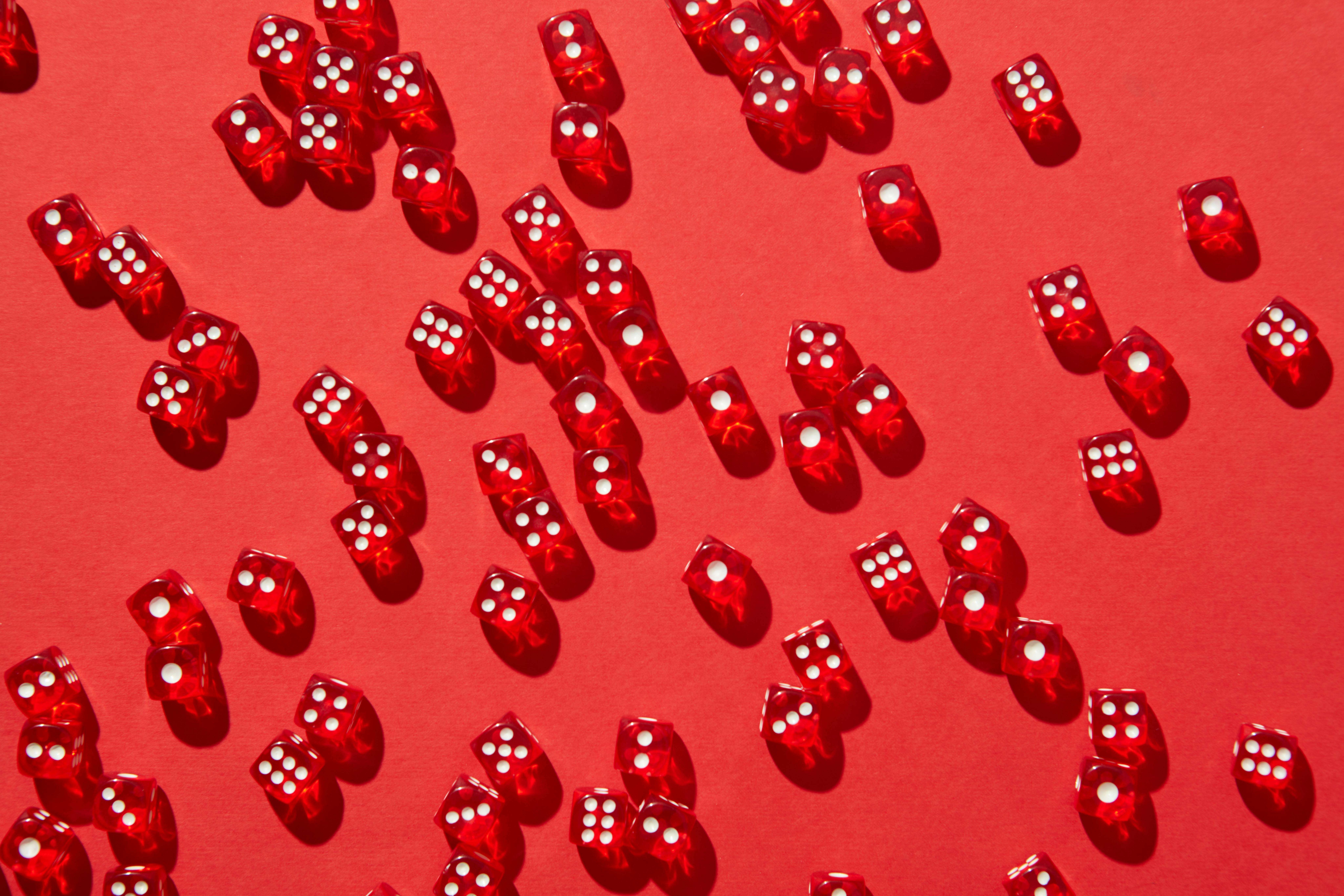 Red Translucent Die on Top of Black Surface · Free Stock Photo