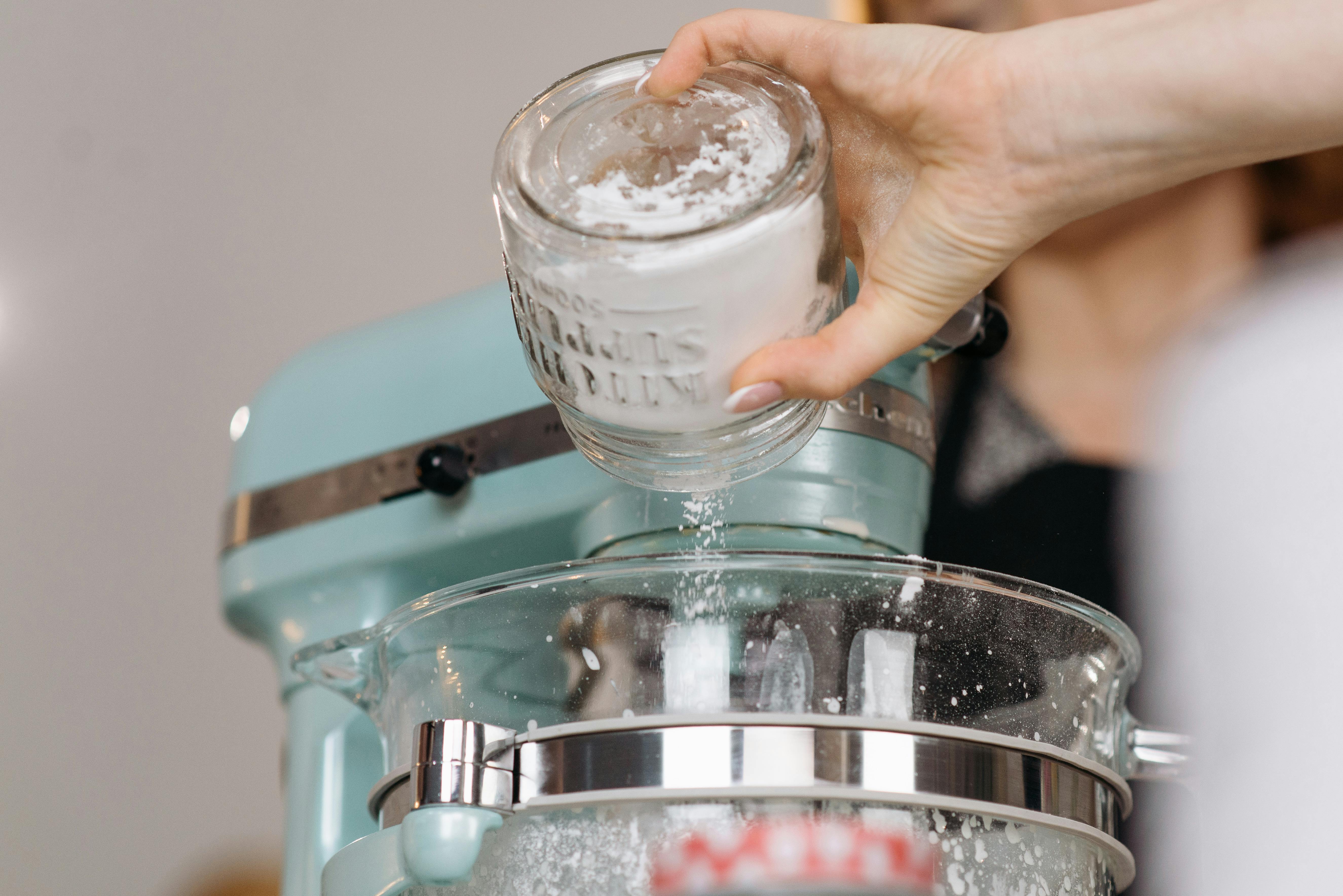 Person Pouring Flour on a Mixer · Free Stock Photo
