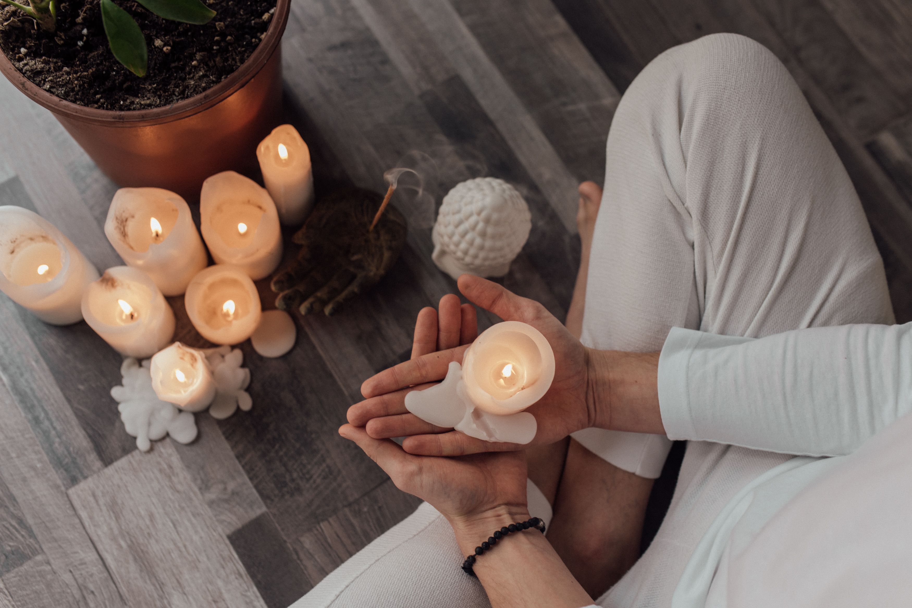 A Person Sitting with Crossed Legs Holding White Lighted Candle · Free ...