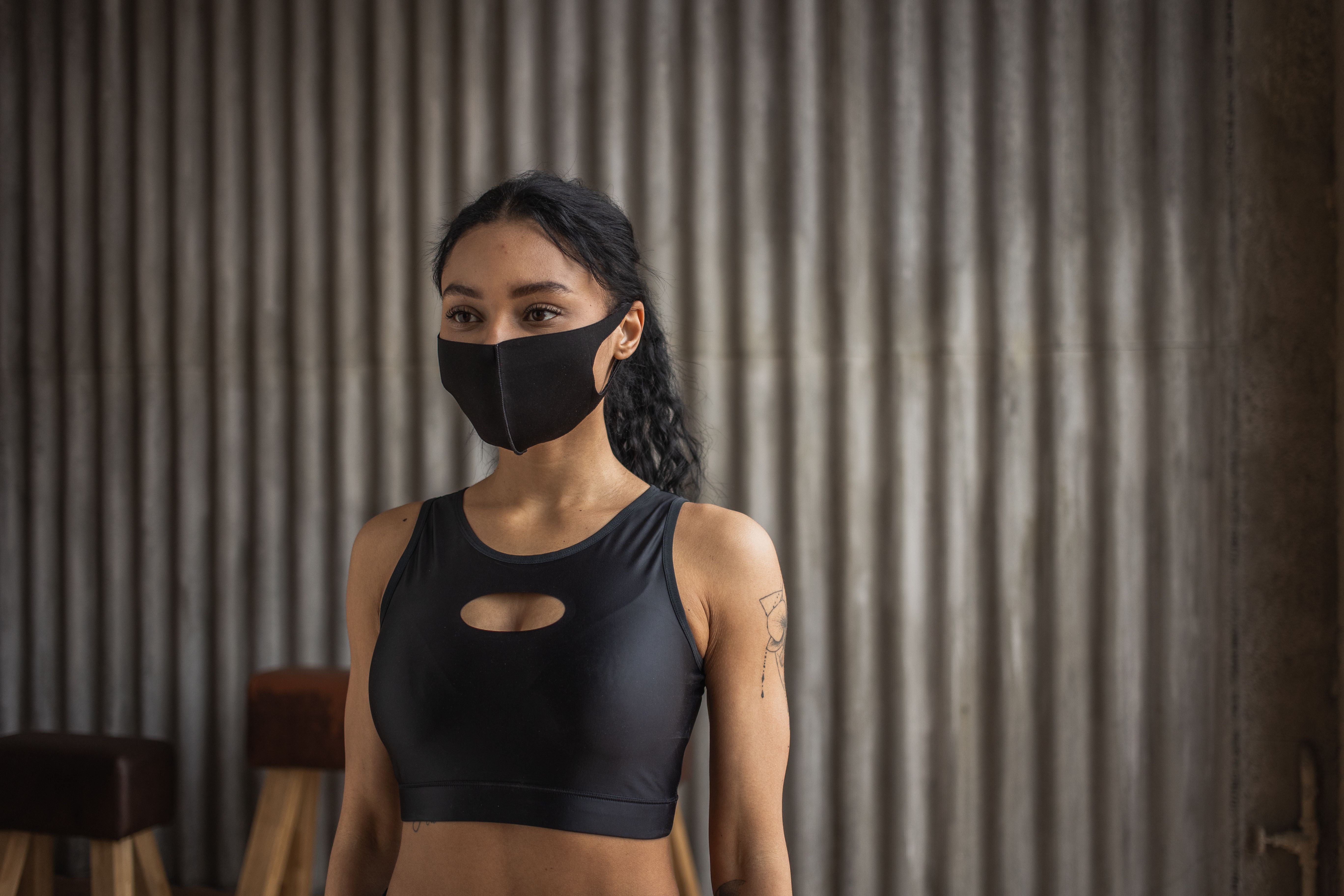 Black athlete in cloth face mask working out with barbell · Free Stock ...