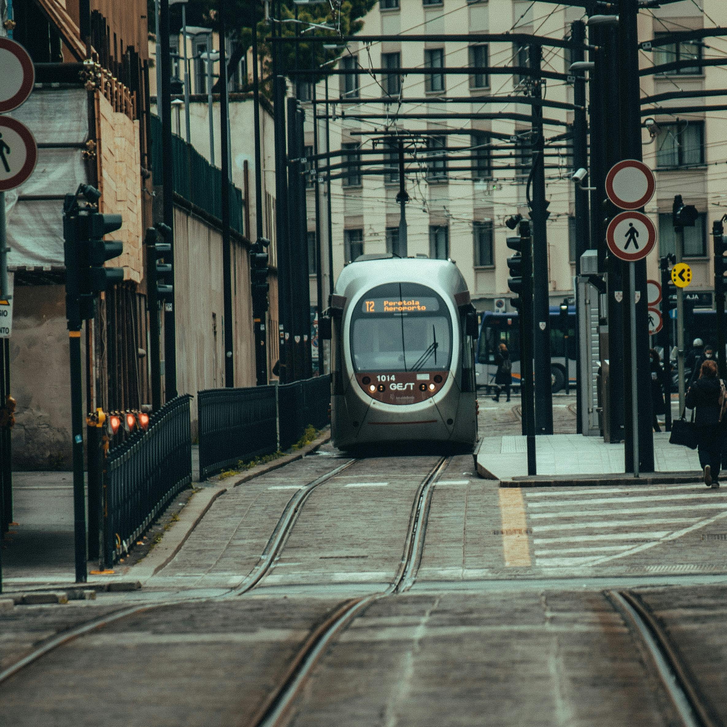 Tram Driving by Edge of Forest · Free Stock Photo