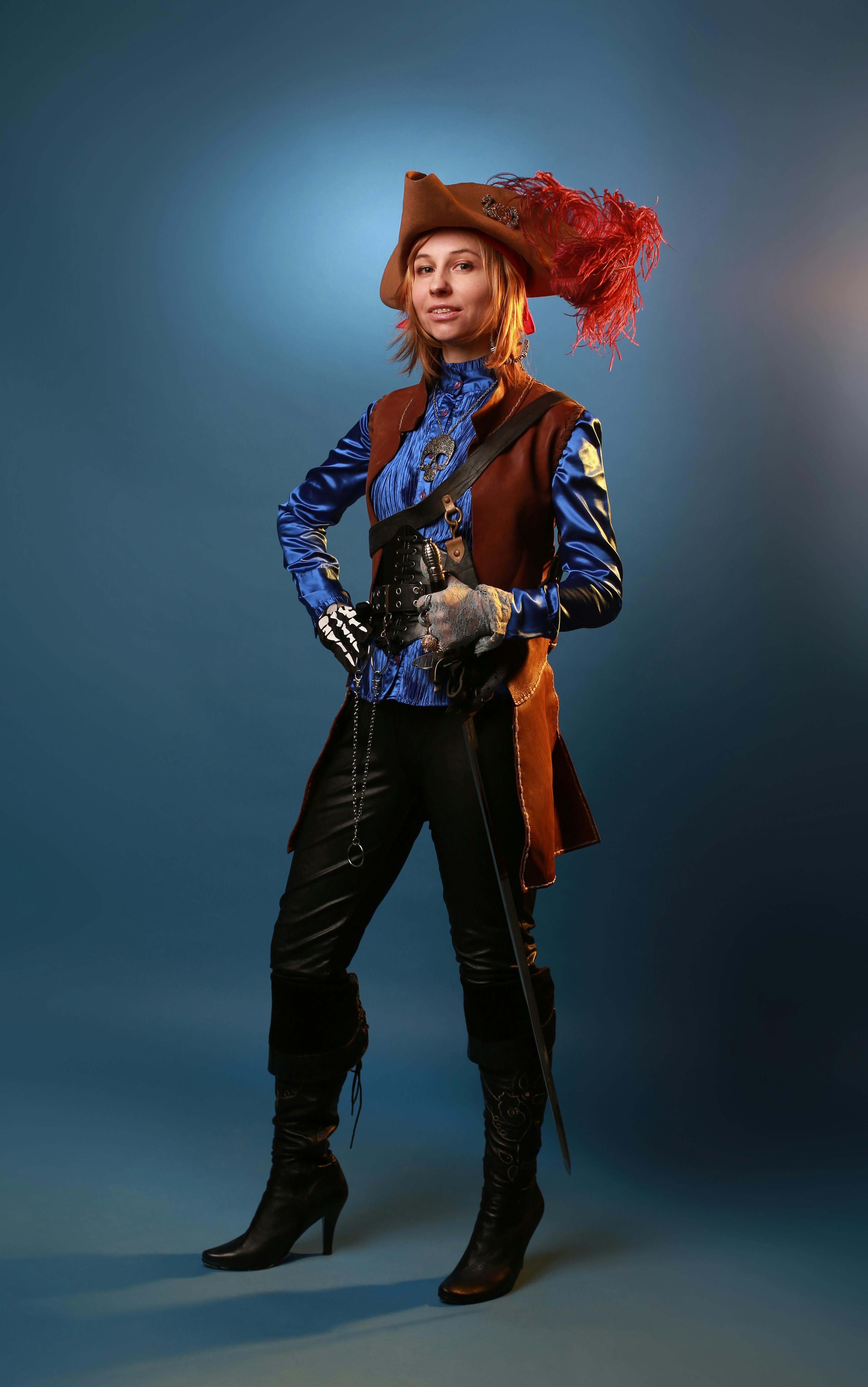 Model in pirate costume on gray background · Free Stock Photo