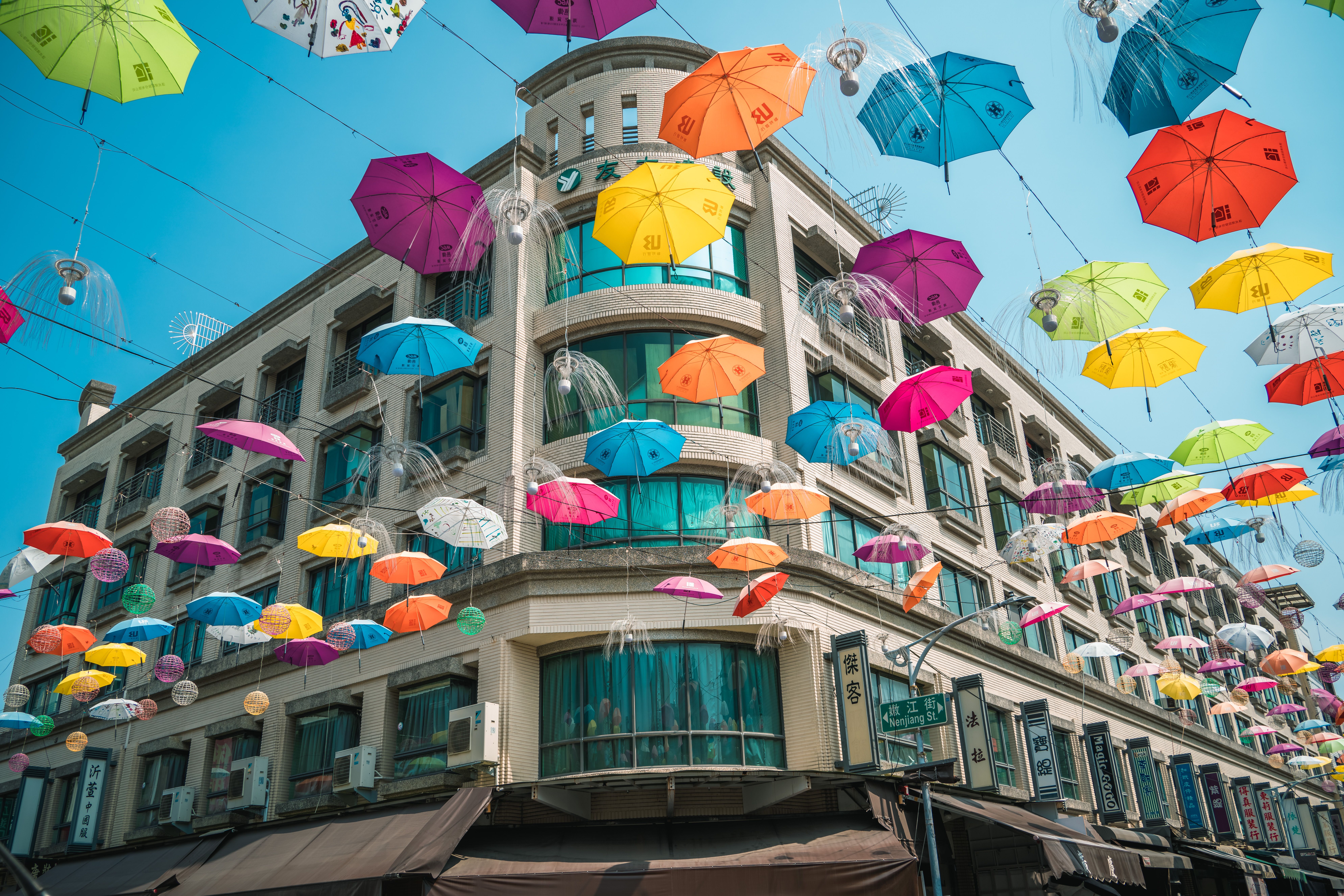 Umbrellas Hanging on the Streets Beside a Building · Free Stock Photo