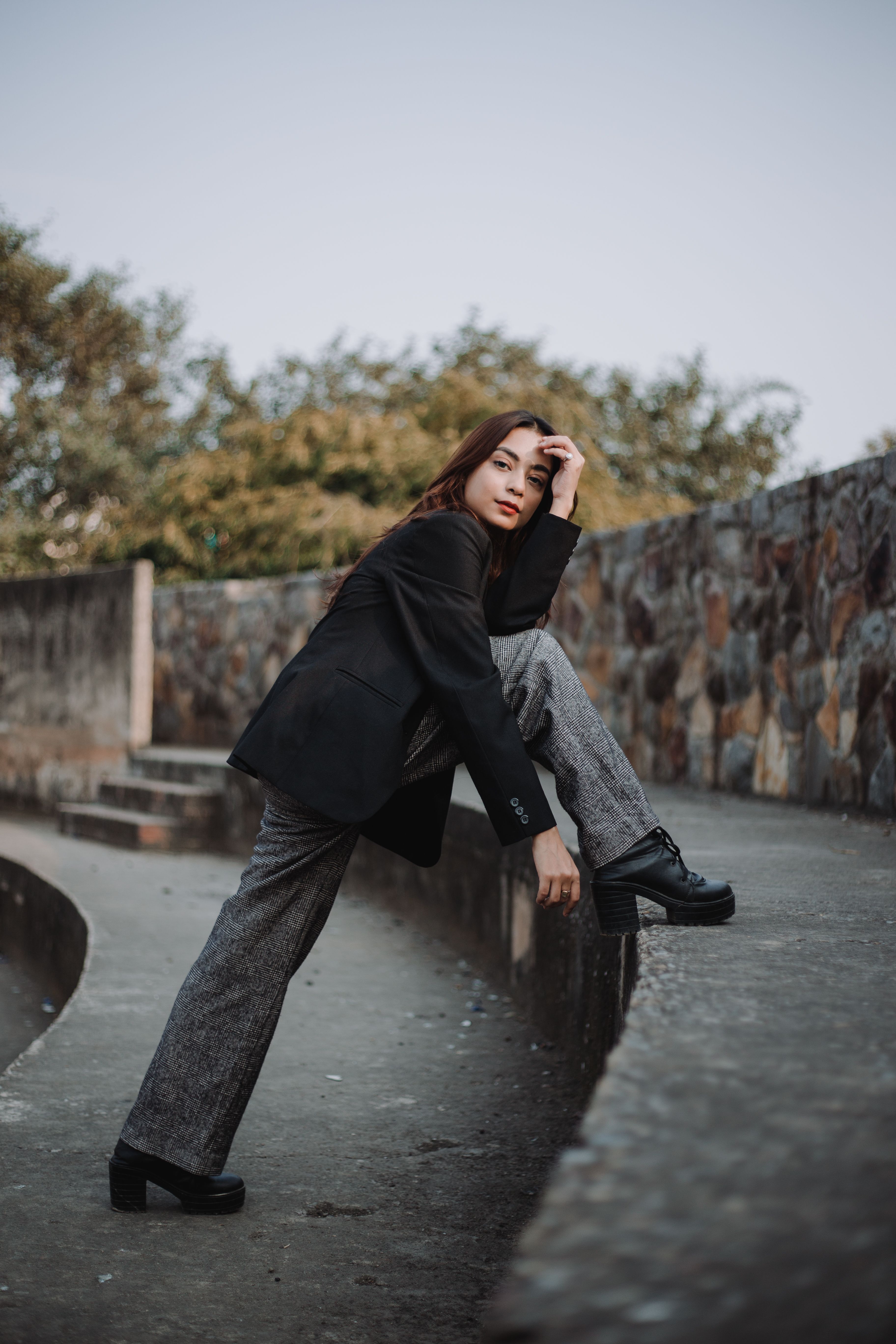 Confident woman with one leg bent standing on stairs · Free Stock Photo