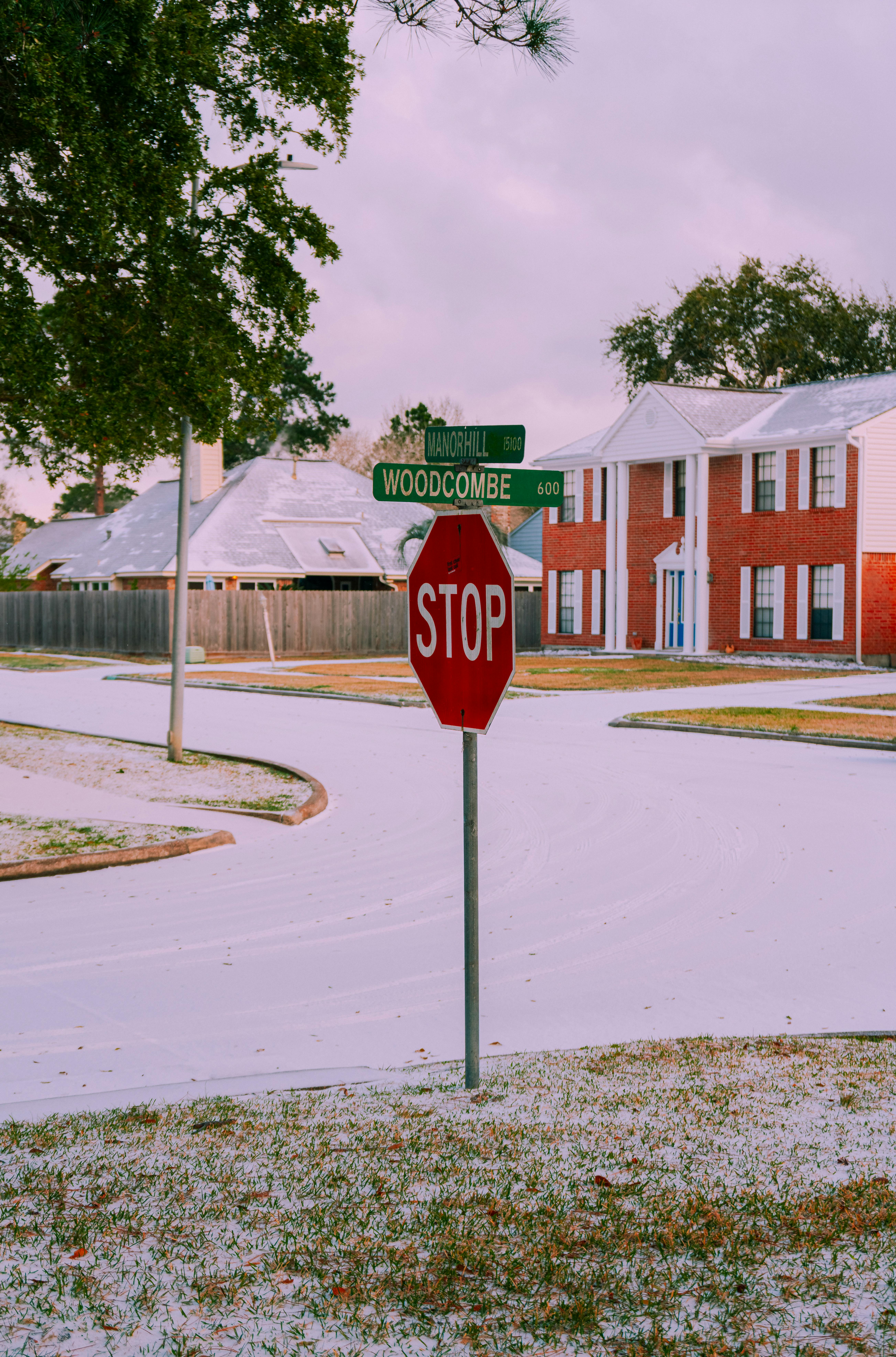 A Stop Road Sign Near the Houses · Free Stock Photo