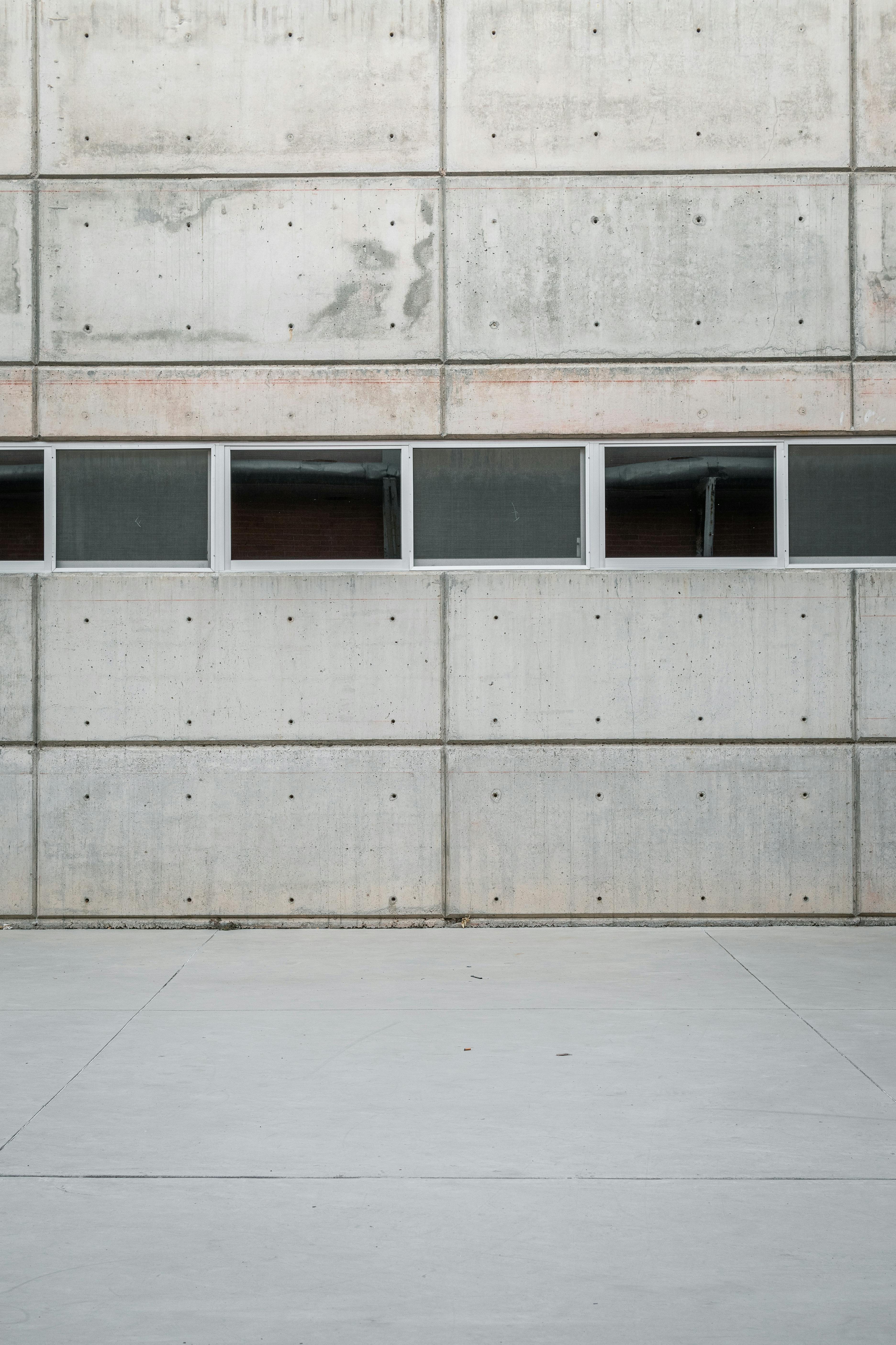 Glass Windows on Concrete Wall · Free Stock Photo