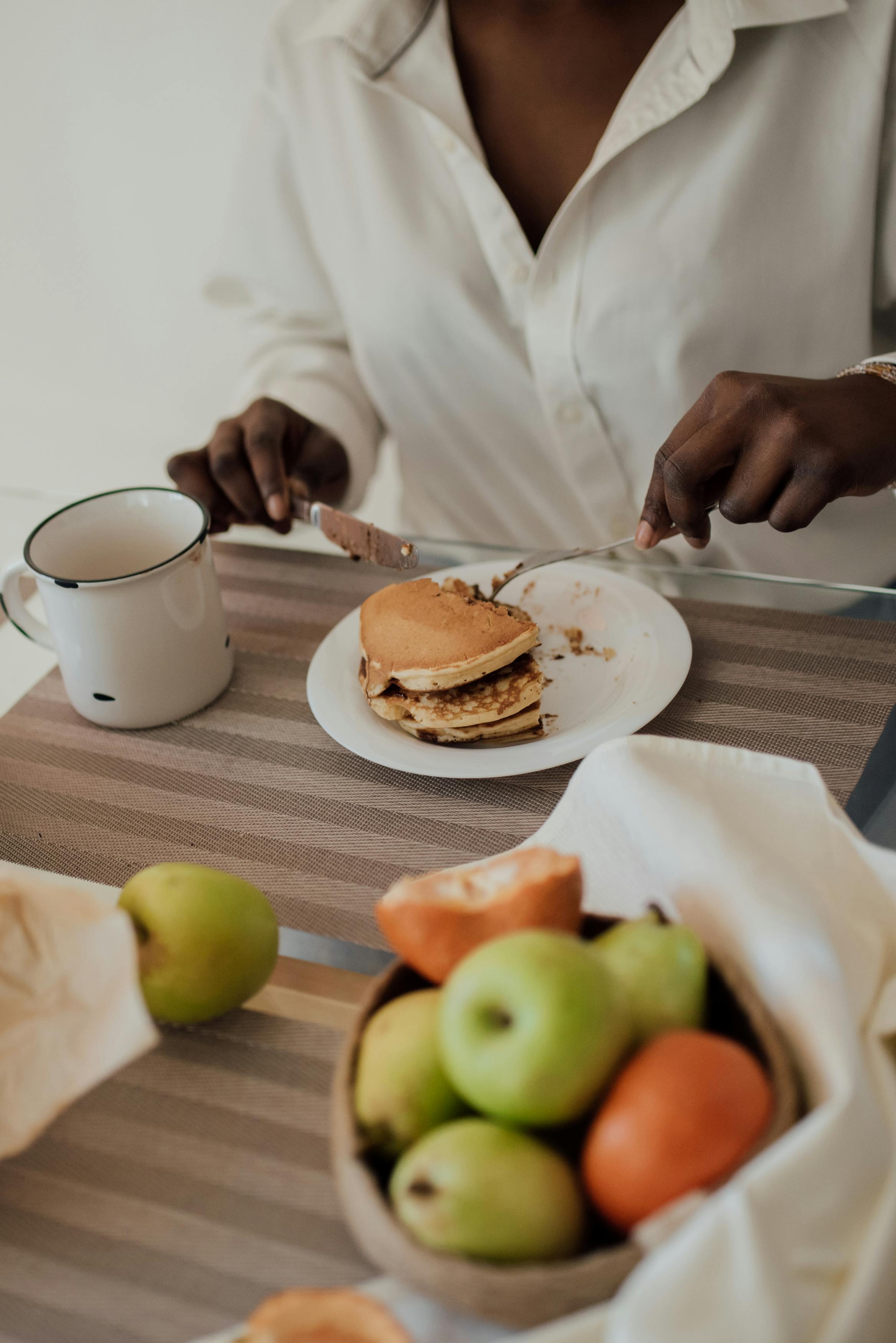 A Woman Eating Pancakes · Free Stock Photo