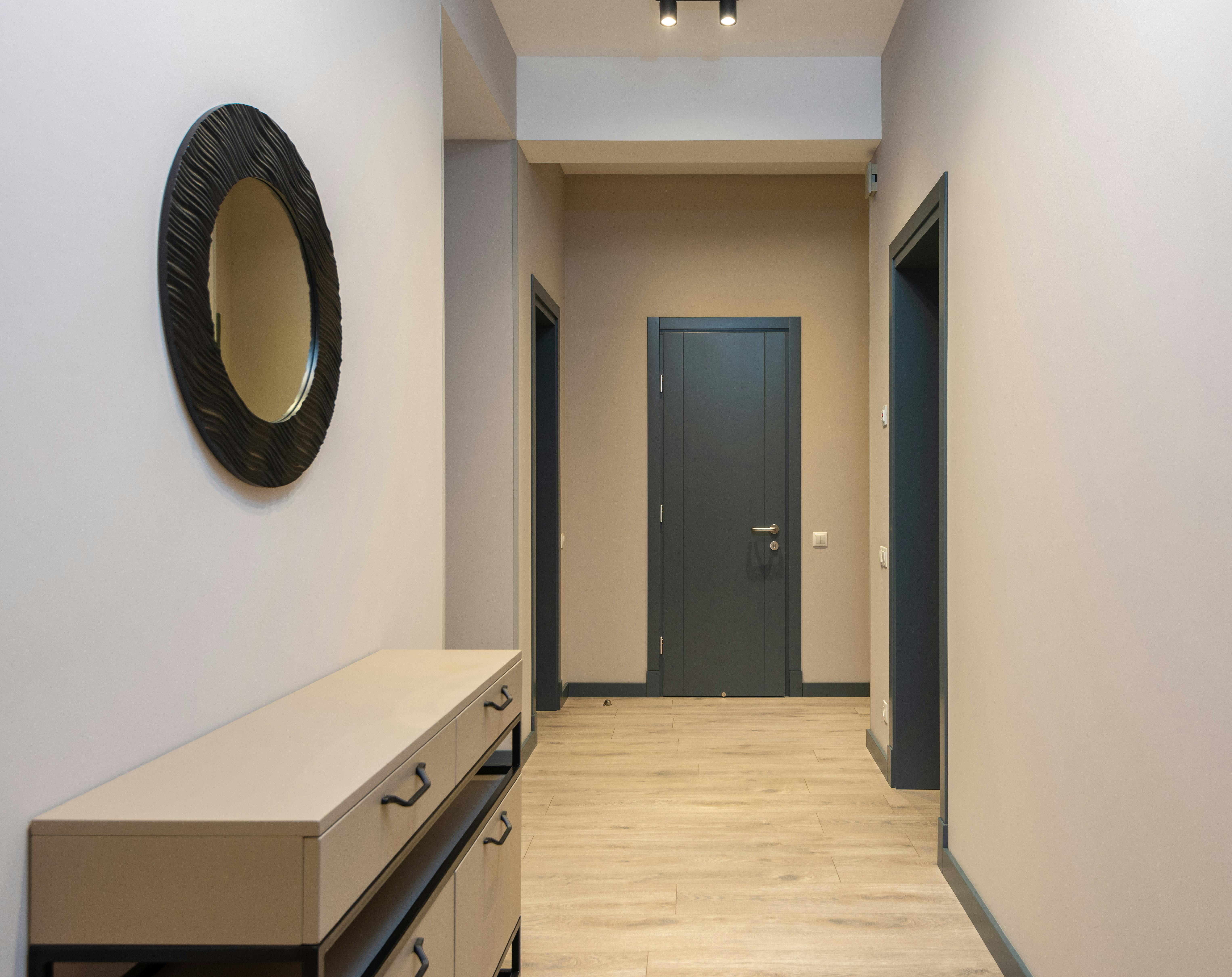 Modern apartment hallway with wooden parquet and walls · Free Stock Photo