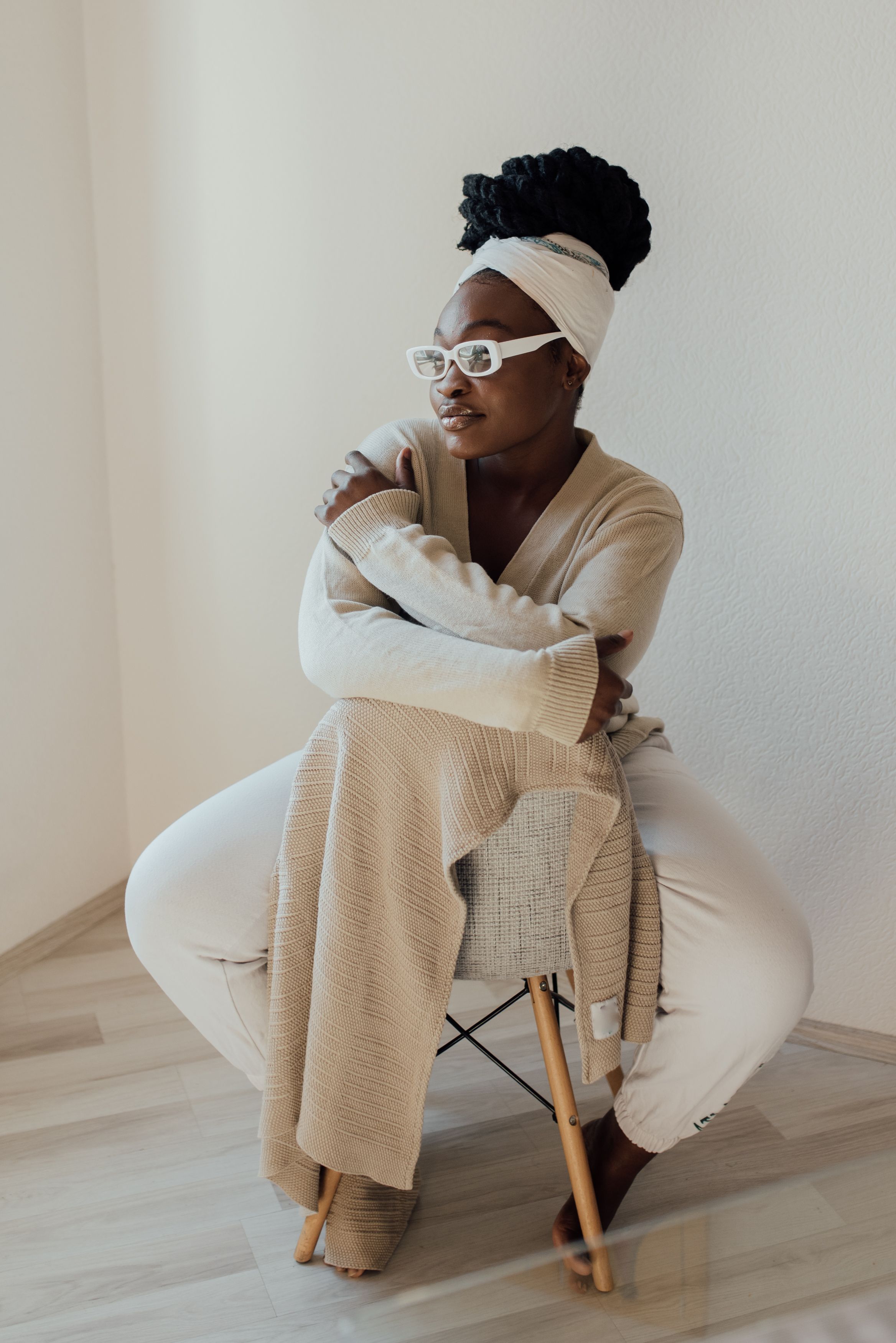 Woman Wearing a Cardigan Sitting on a Chair · Free Stock Photo