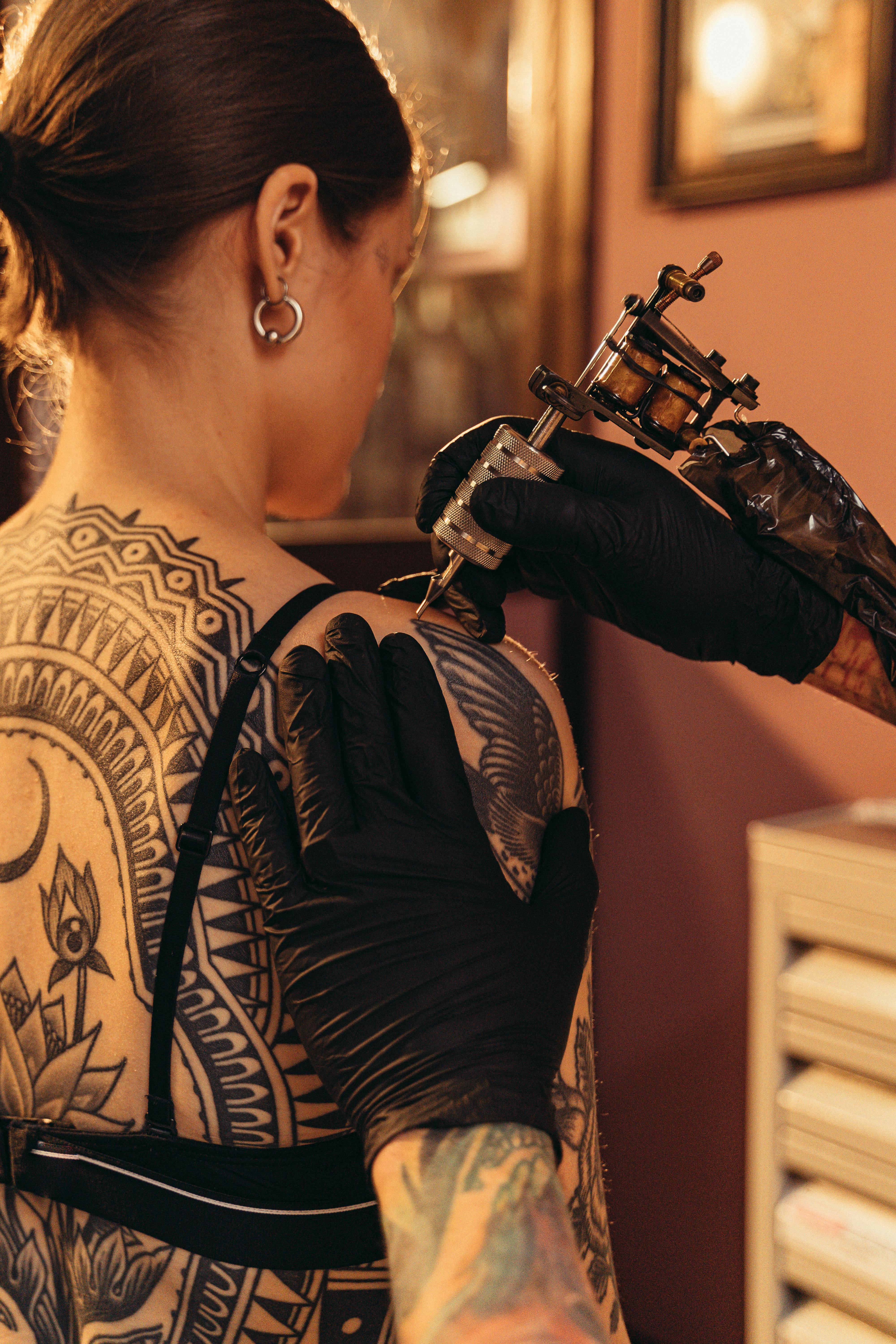 Woman Having a Tattoo on Shoulder · Free Stock Photo