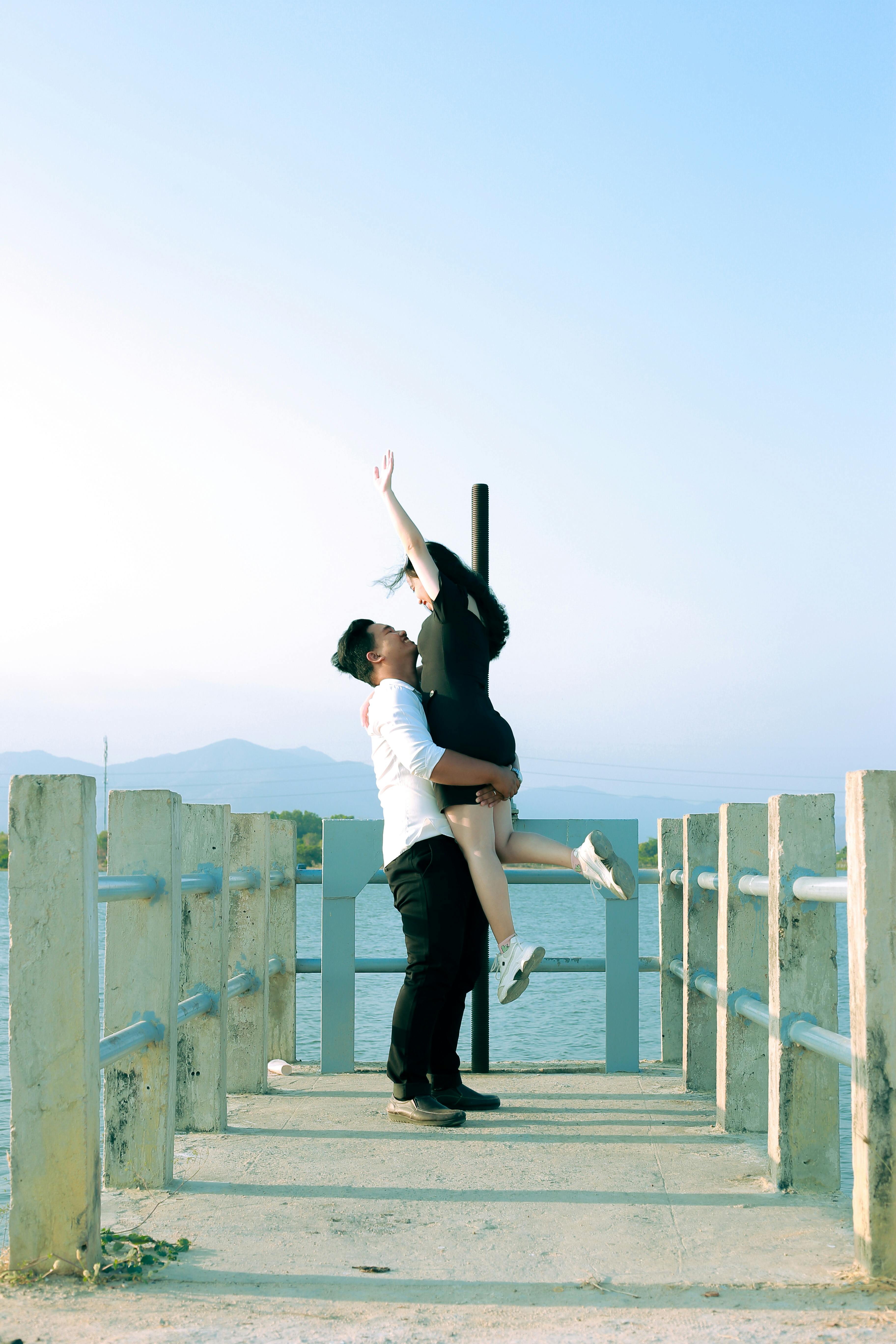 A Man Carrying a Woman on His Shoulder · Free Stock Photo