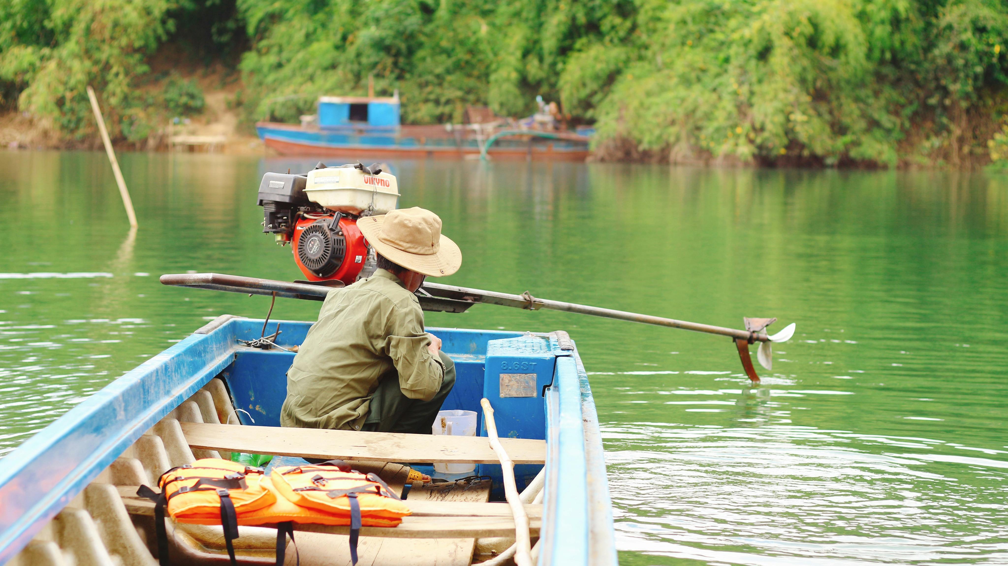 A Couple Sitting Back to Back while Riding a Boat · Free Stock Photo