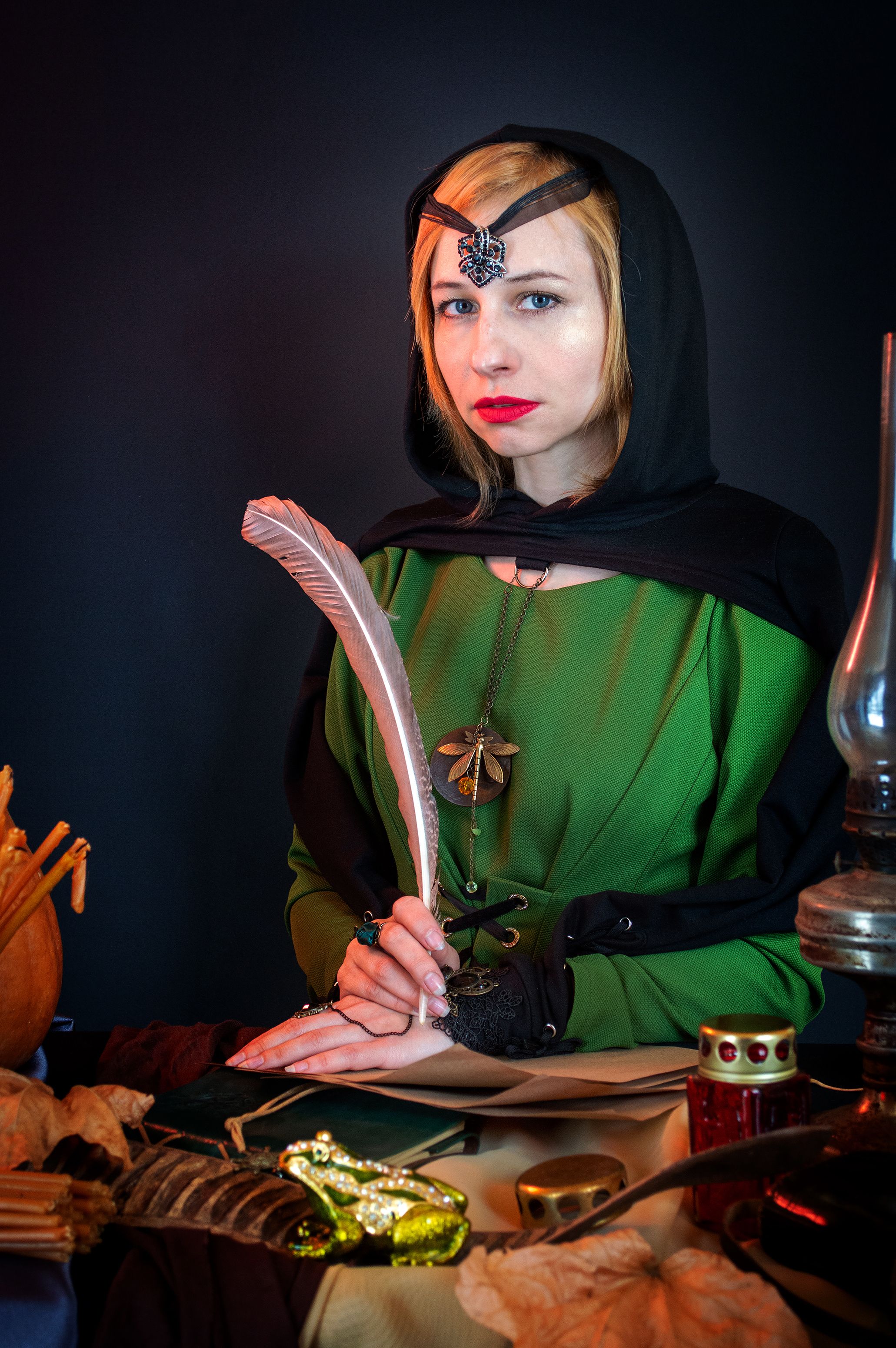 Crop soothsayer with talisman and tarot cards near glowing candle ...